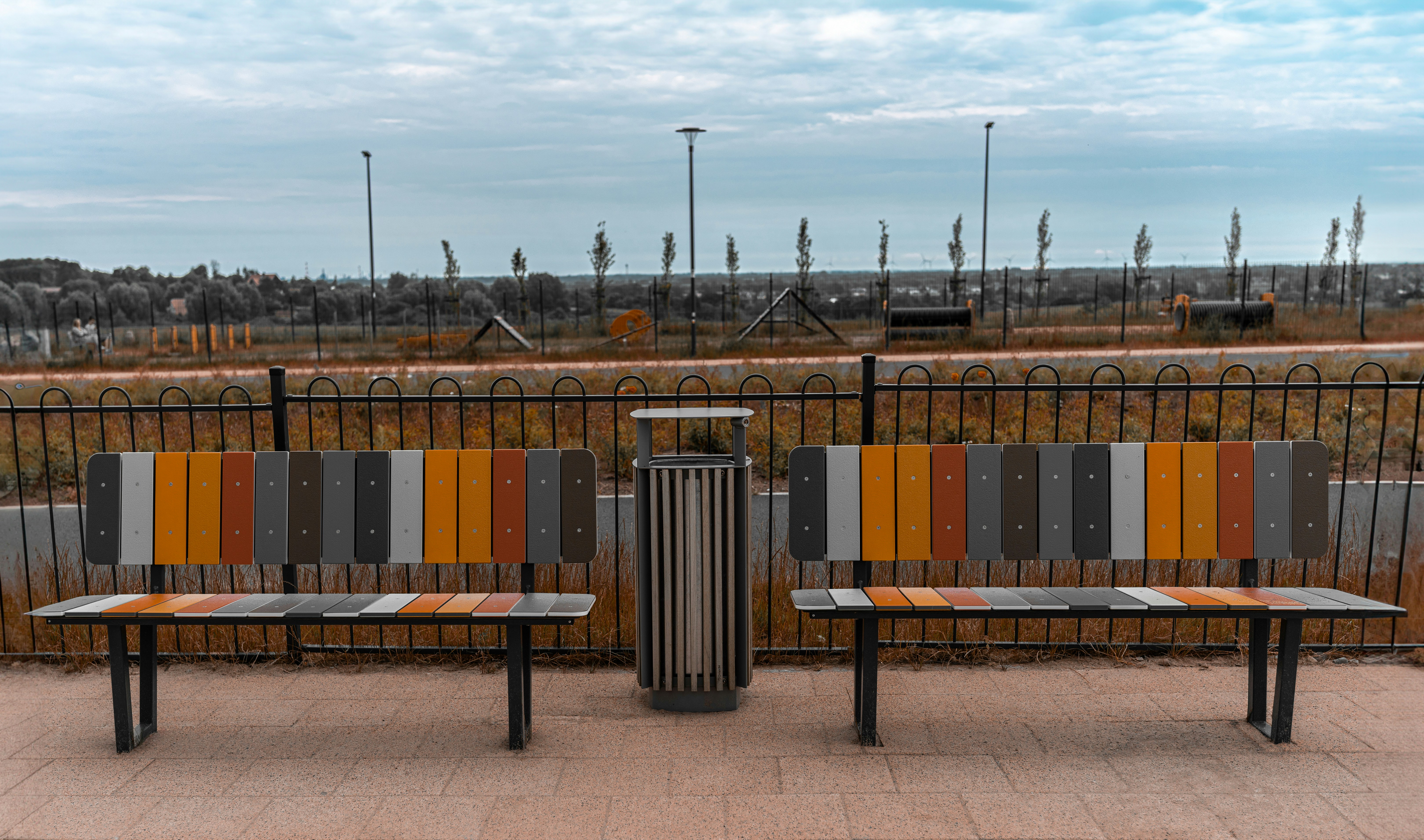 Chromatic Benches Framing a Quiet Transit Moment