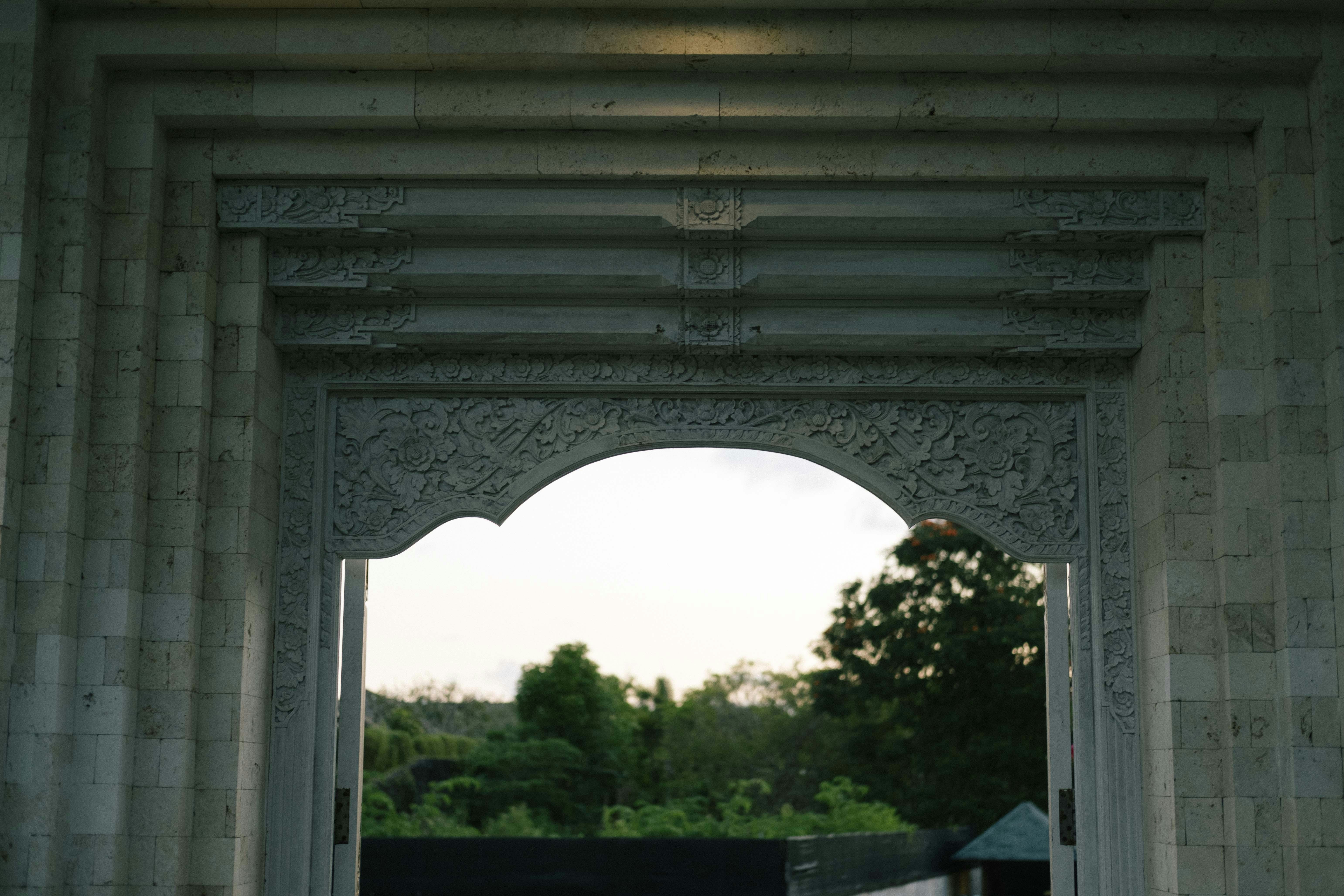 Openwork Gateway: A Stone Arch Framing a Quiet Garden Beyond