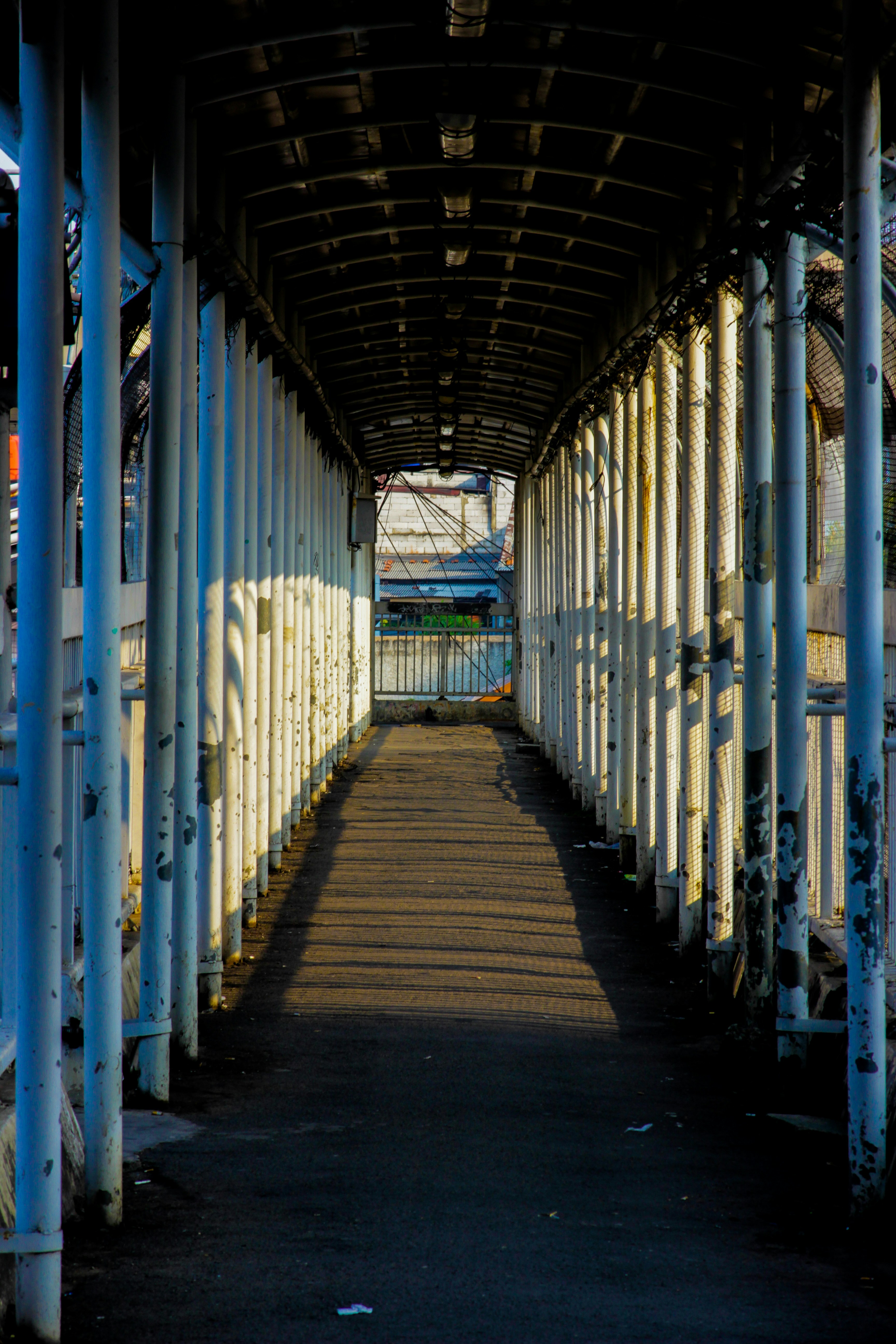 Converging Lines in a Pier Tunnel Toward the Distant Light