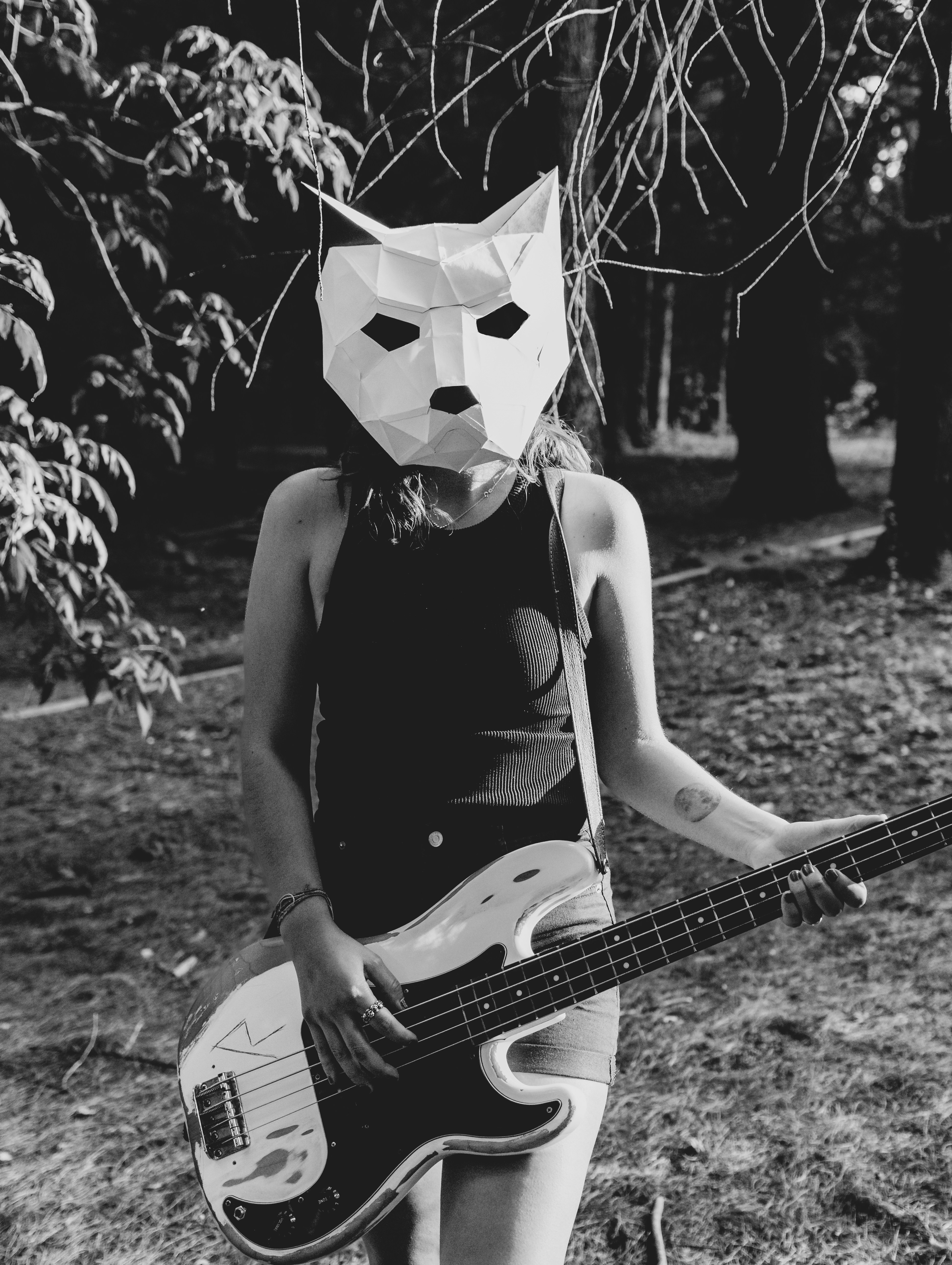 A girl with a paper mask playing a bass guitar photo – Free Ciudad de ...