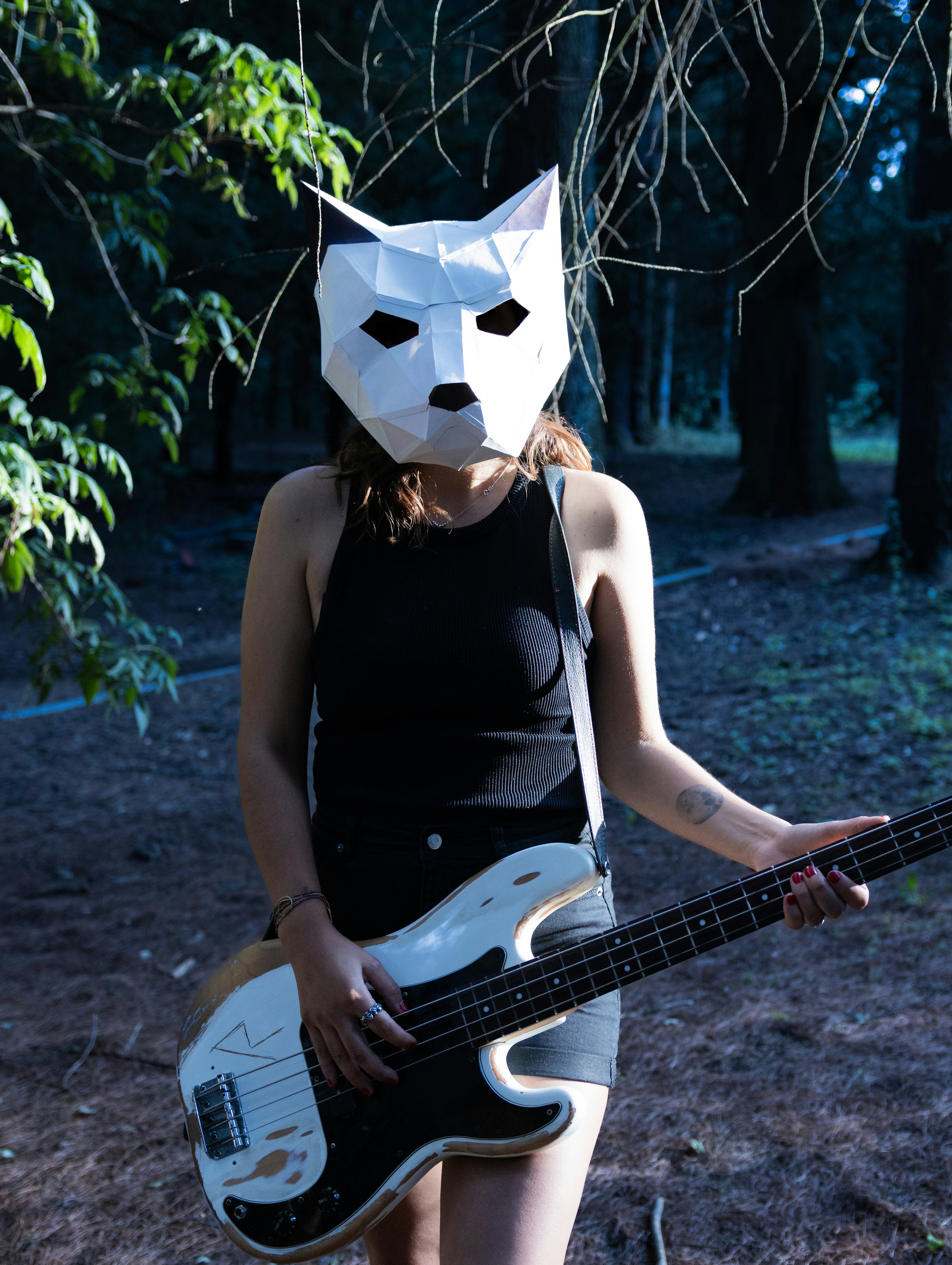 Geometric Mask, White Bass, and Dappled Forest Light