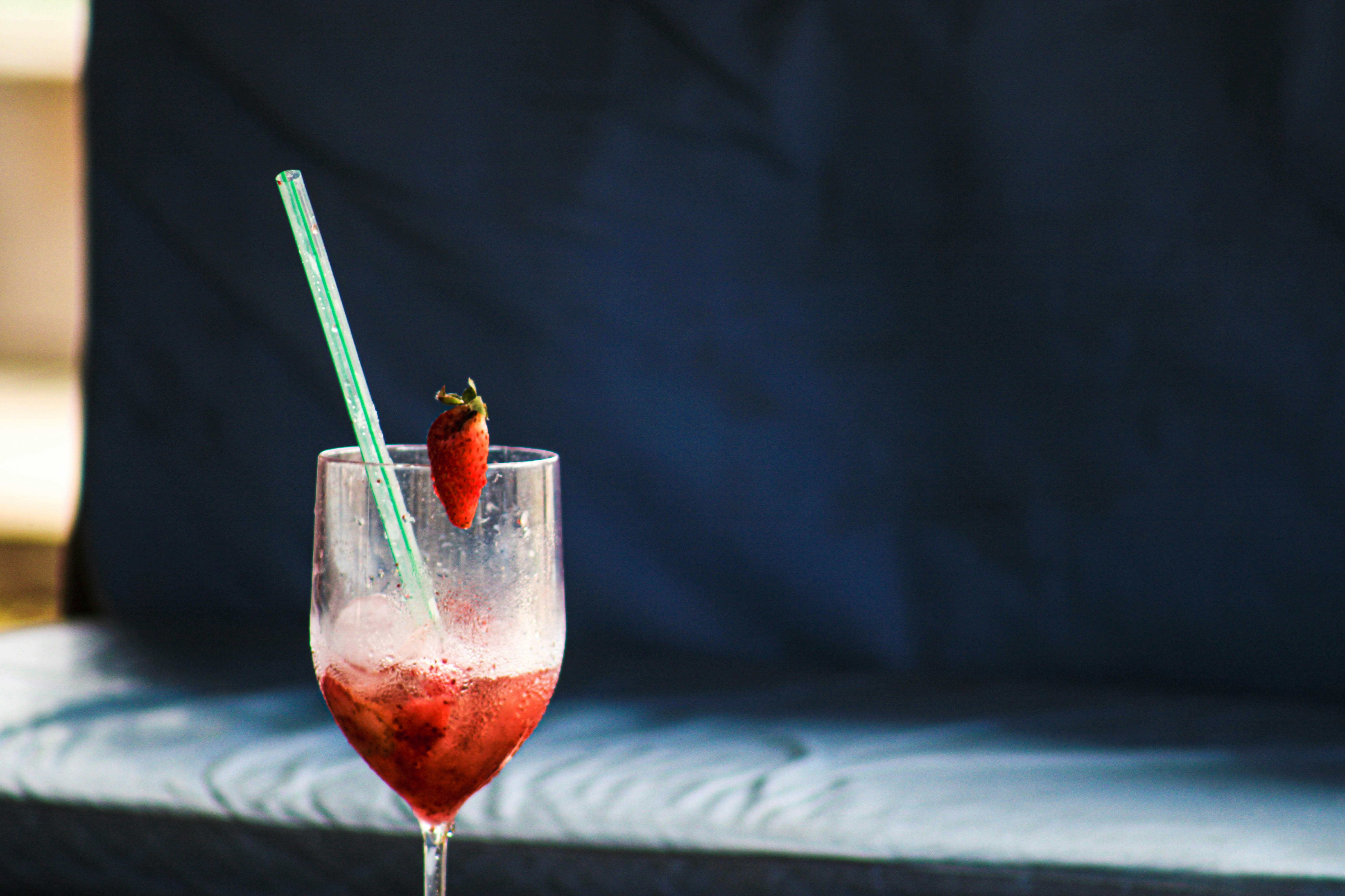 A drink with a straw and a strawberry in it photo – Free Alcohol Image ...