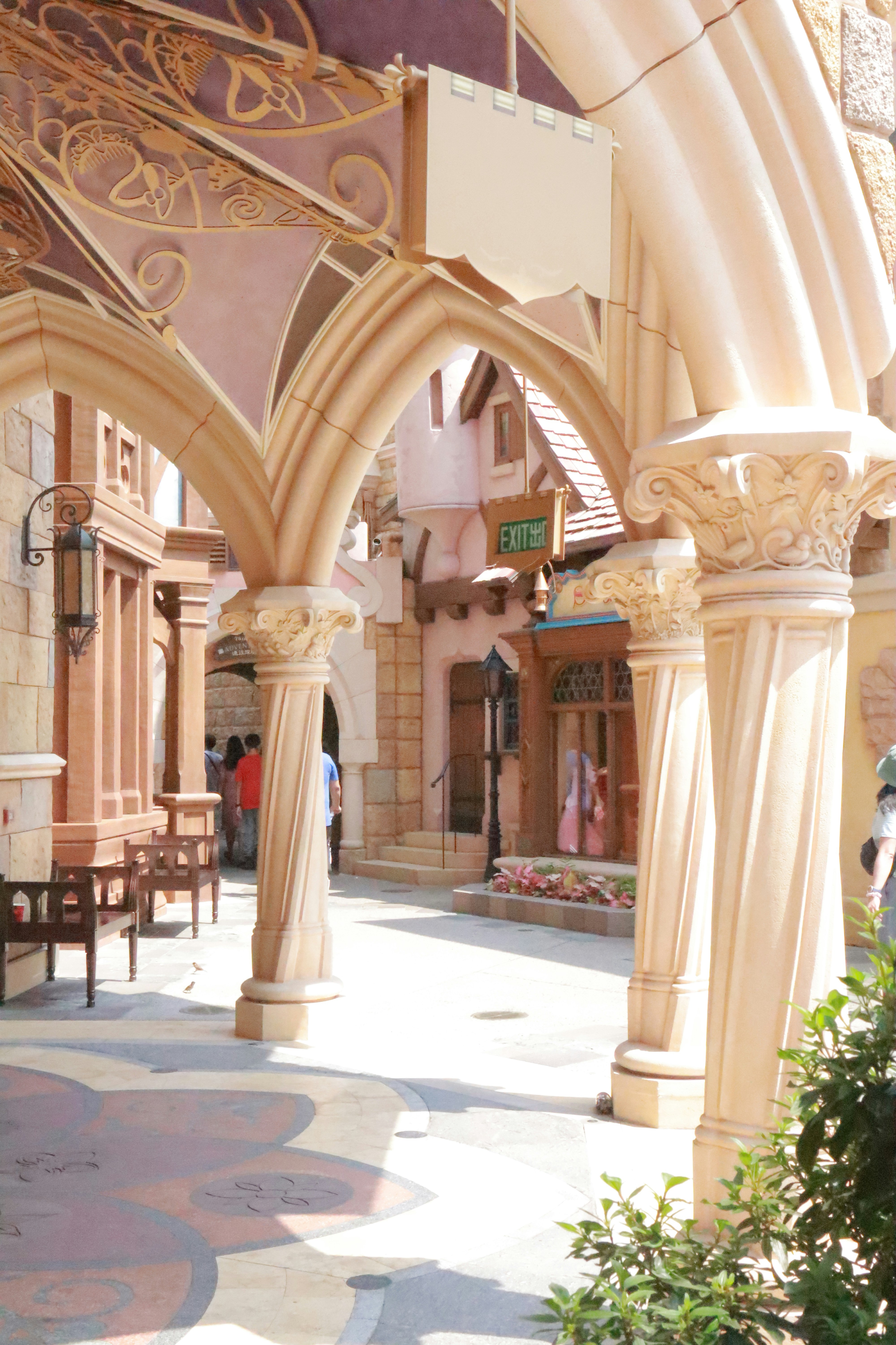 A walkway in a shopping mall with arches and benches photo – Free ...