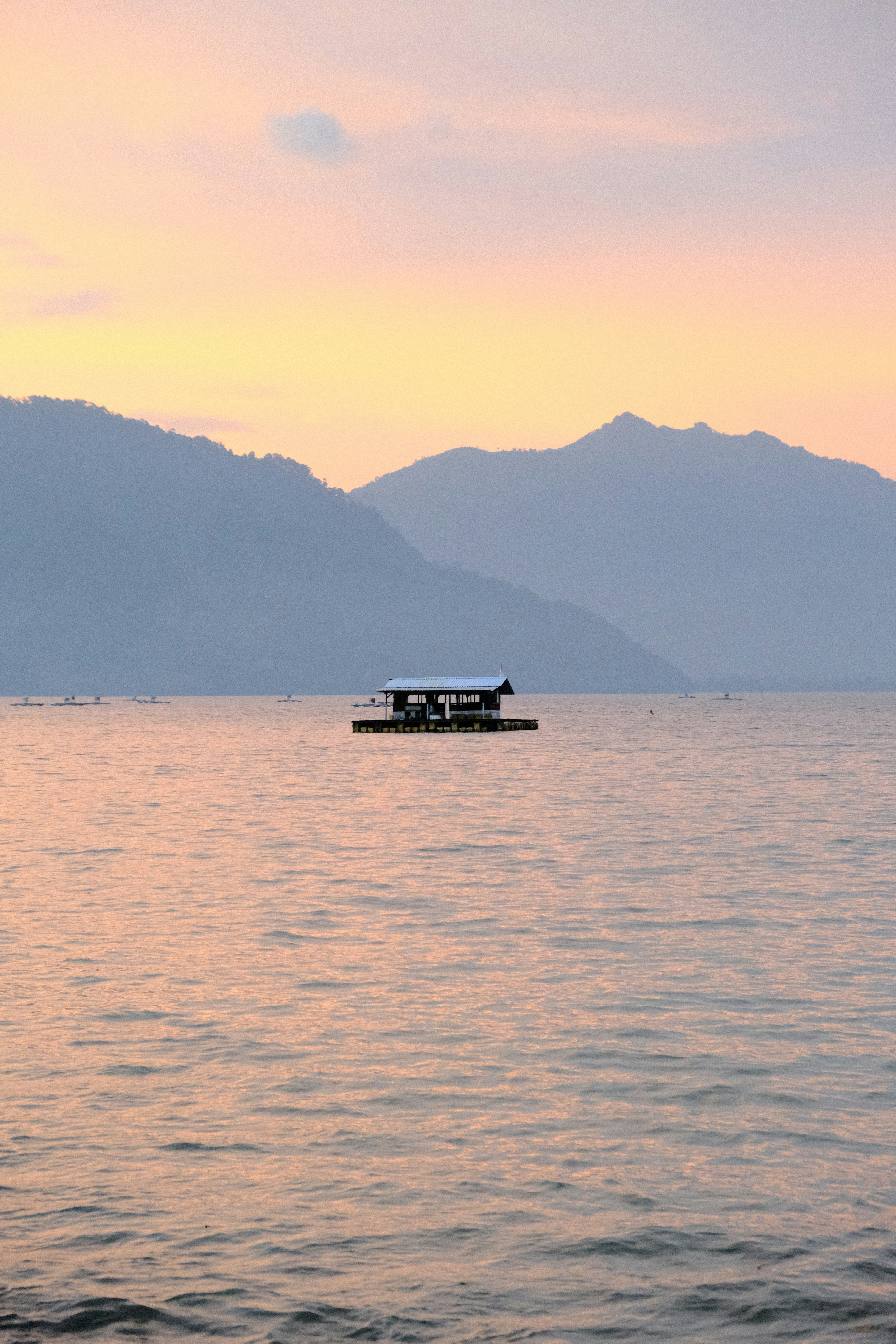 Dusk's Quiet Ferry: A Lone Houseboat on a Pastel Lake
