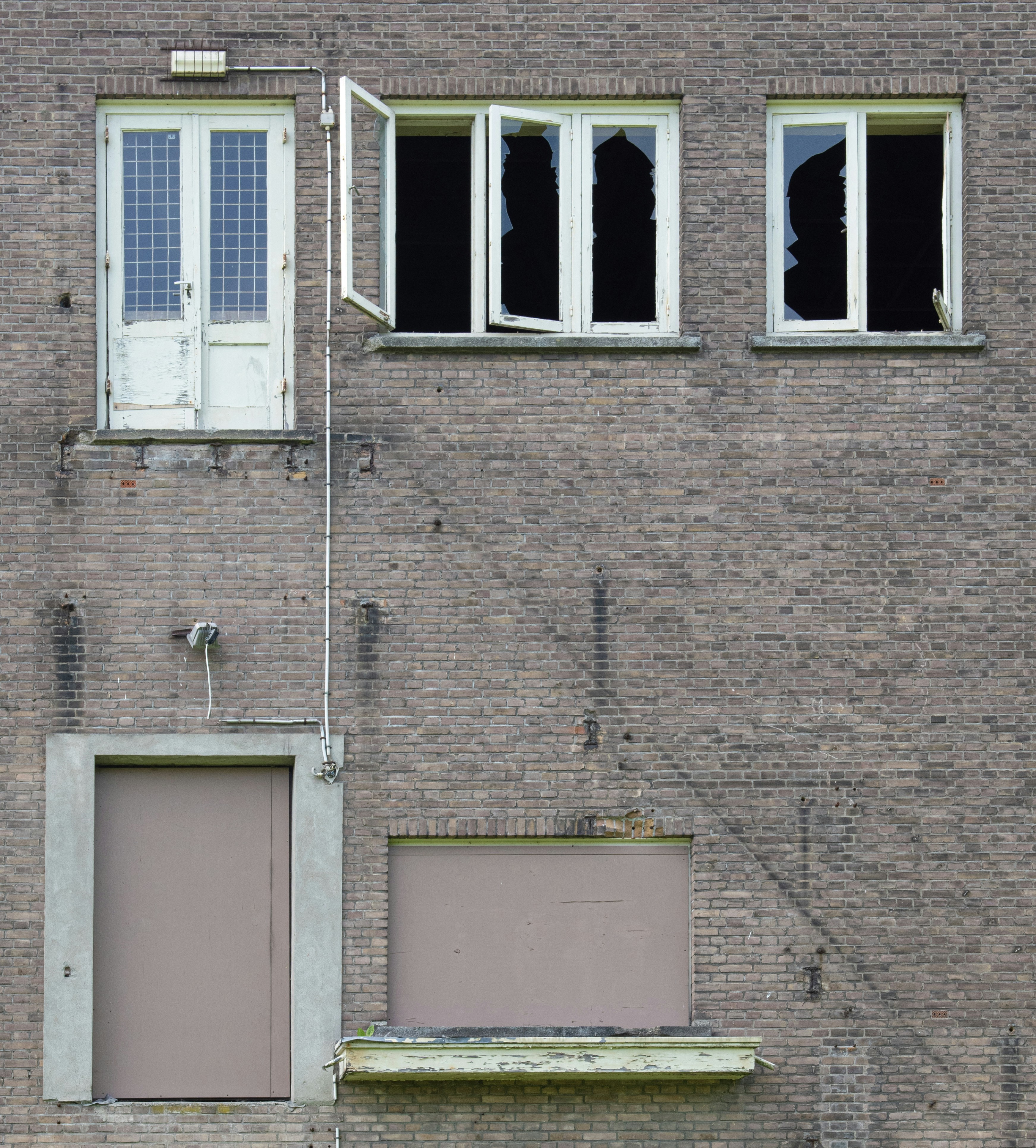 Shattered Windows, Quiet Facade: A Brick Wall's Silent Tale