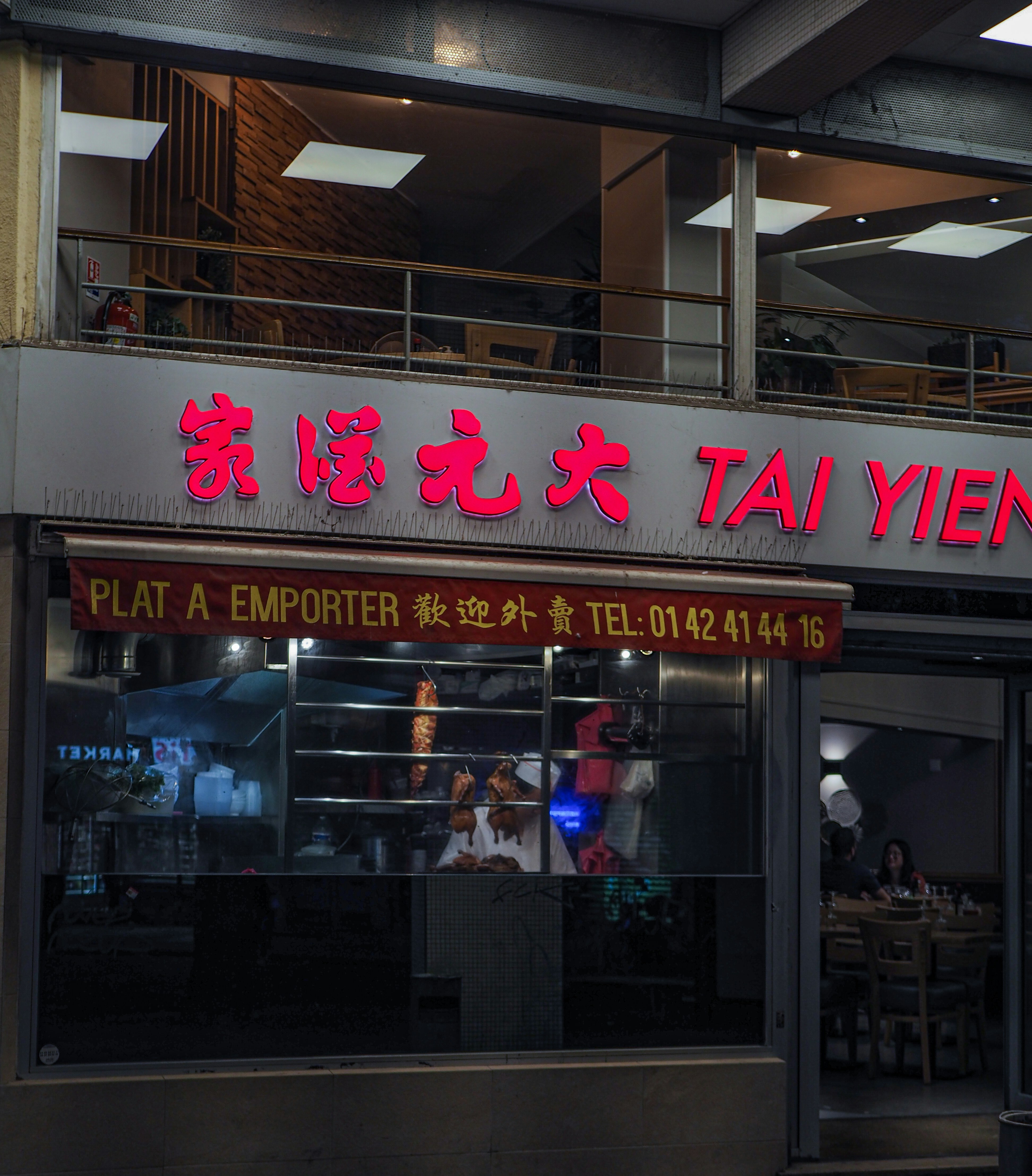 Tai Yien Neon Glow: Red Signage Over a Rotisserie Shopfront
