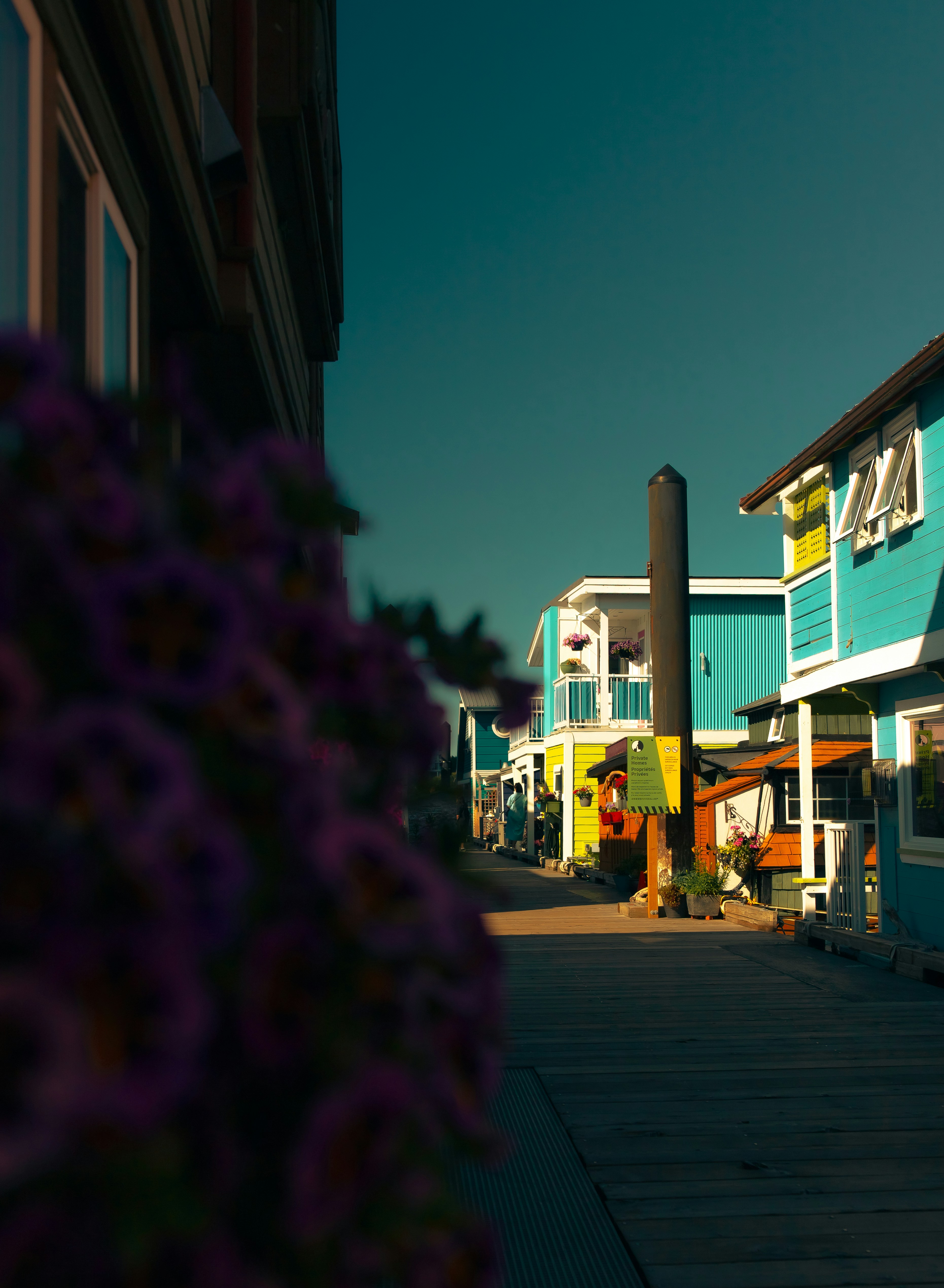Teal Sky, Colorful Cabins: A Coastal Boardwalk Portrait