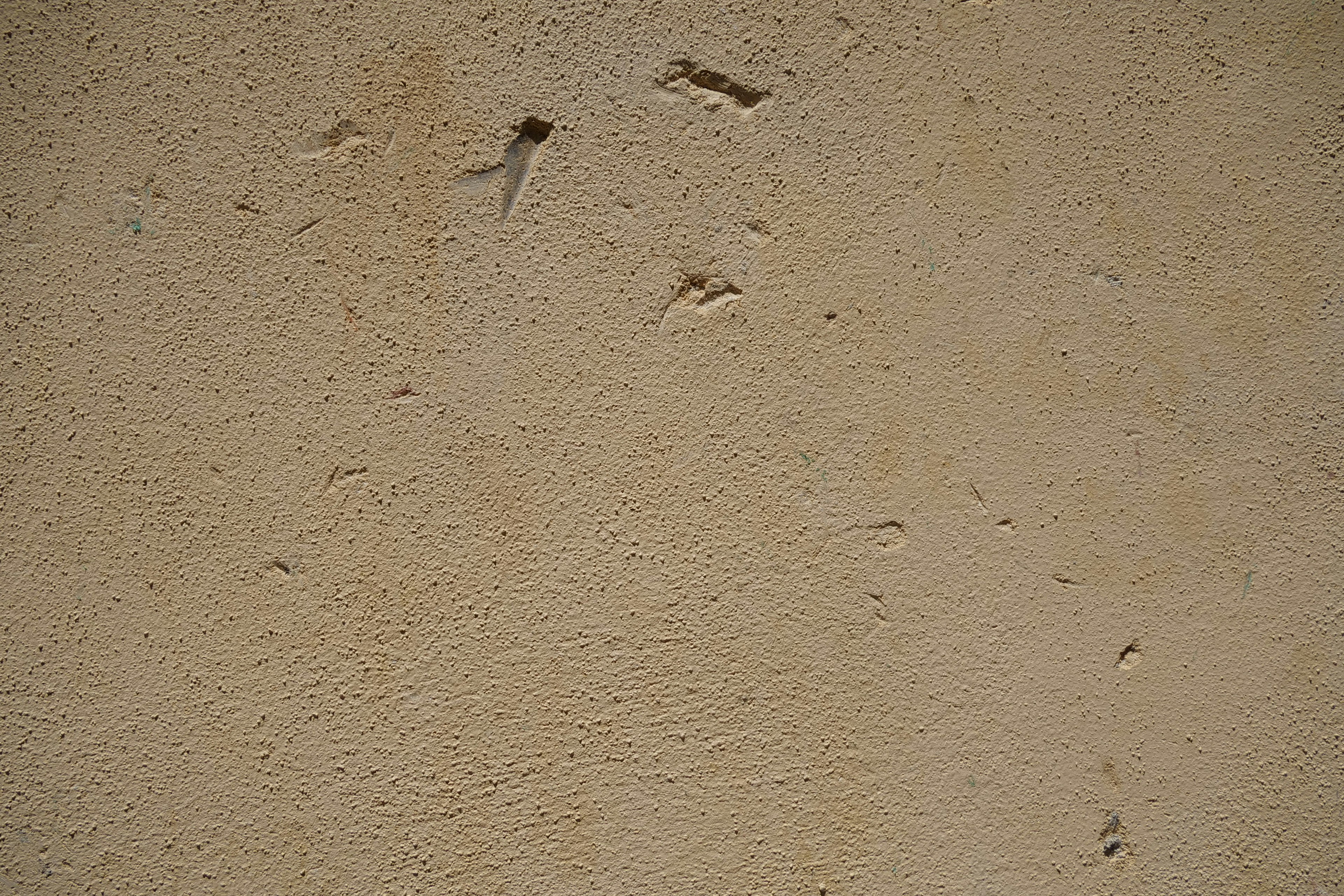 Rough, weathered wall surface with subtle imperfections and texture variations.