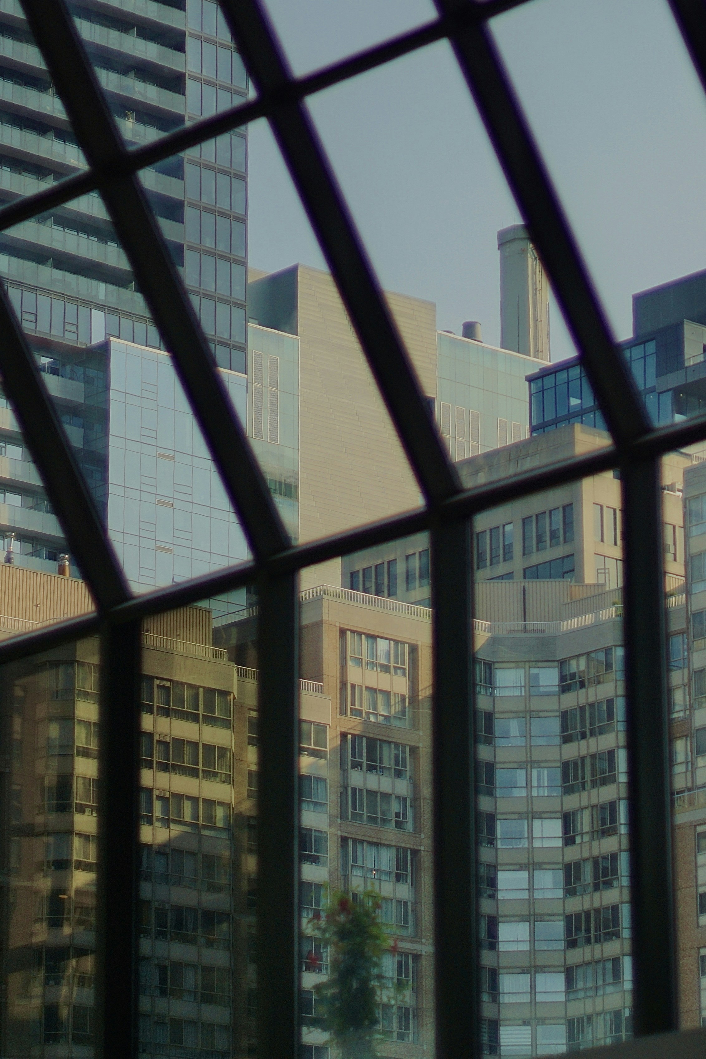 A view of a city through a window photo – Free Building Image on Unsplash