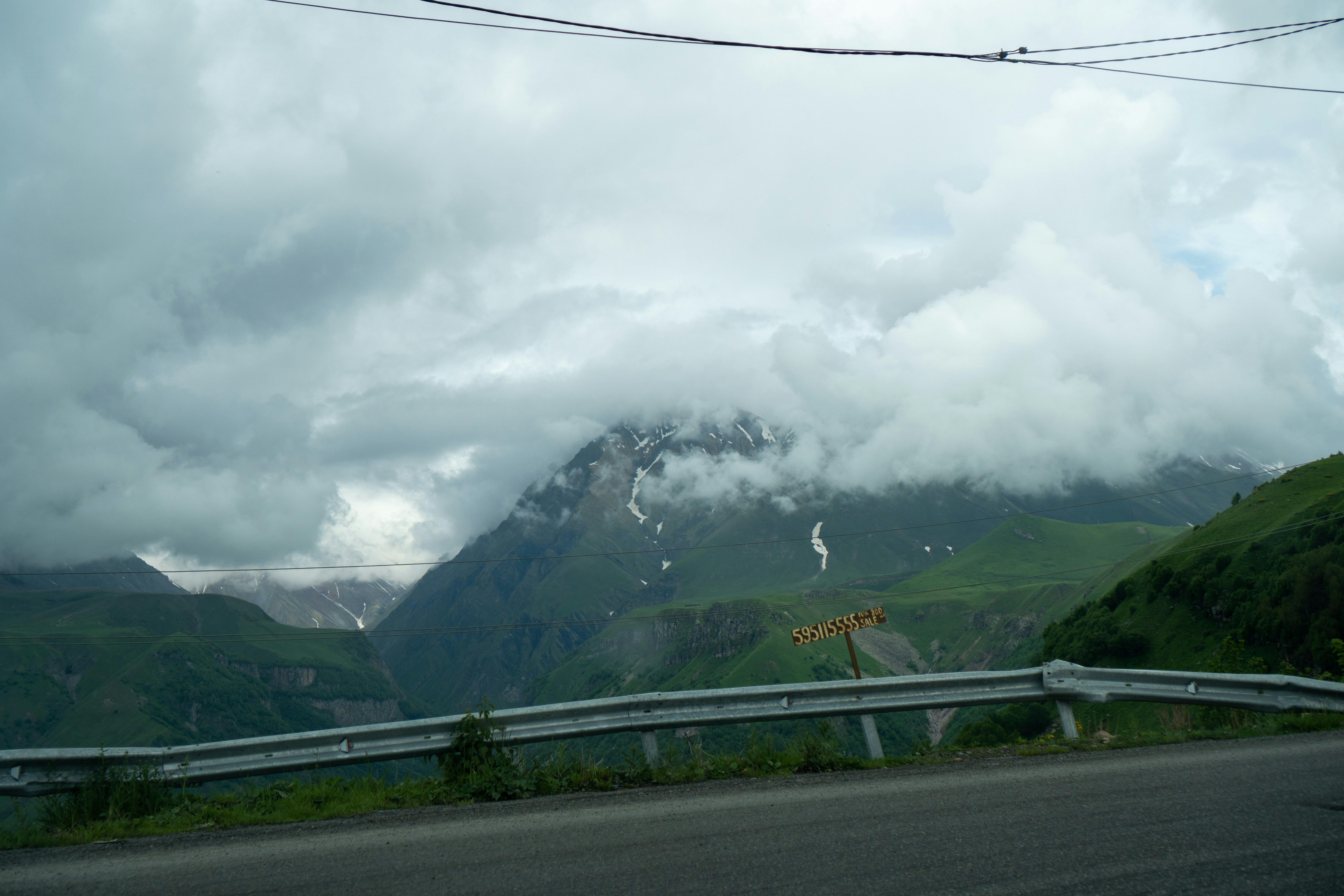 Moody Alpine Ridge Shrouded in Clouds from a Quiet Highway Overlook