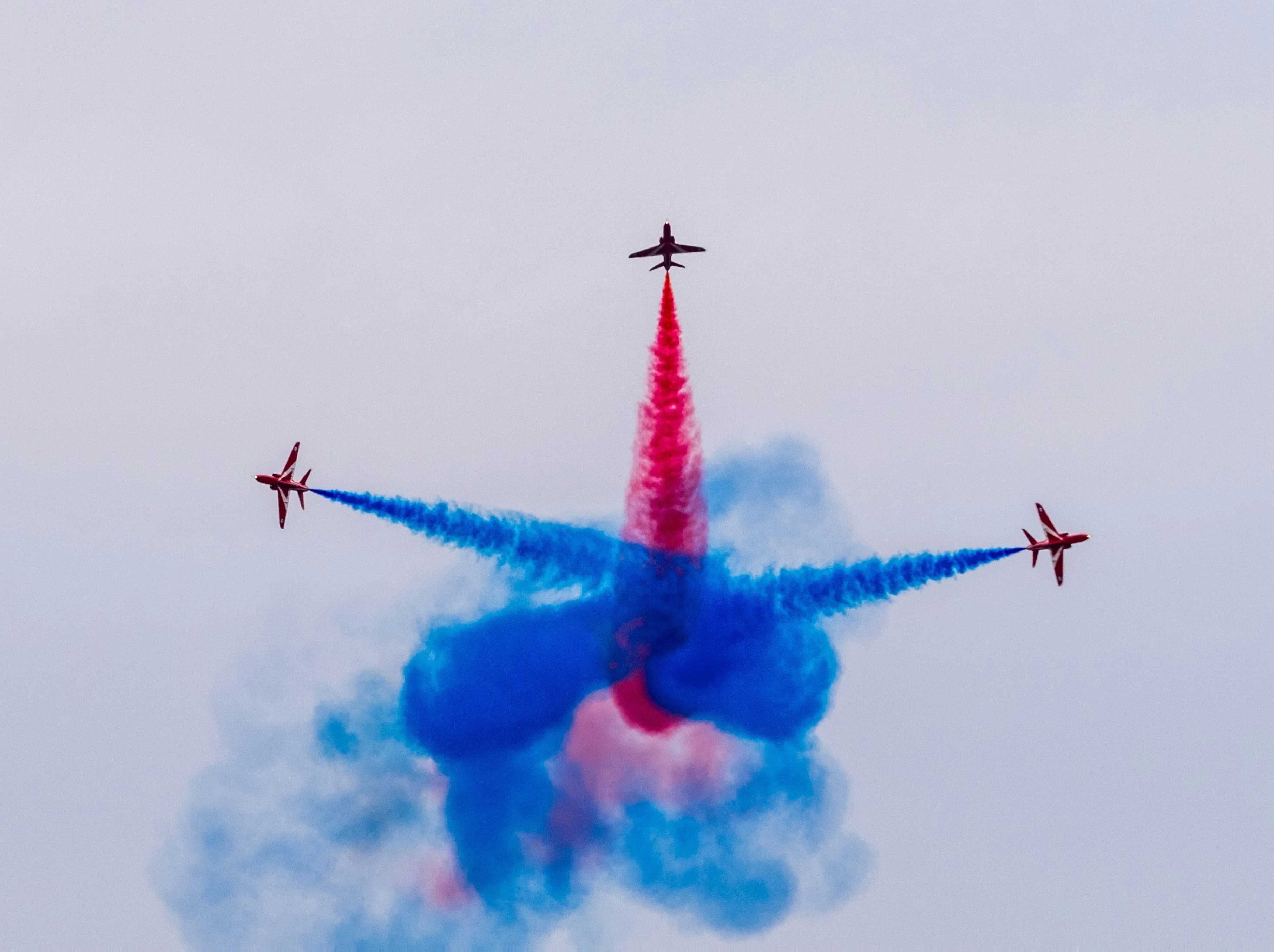 A group of red and blue jets flying through the sky photo – Free Beja ...