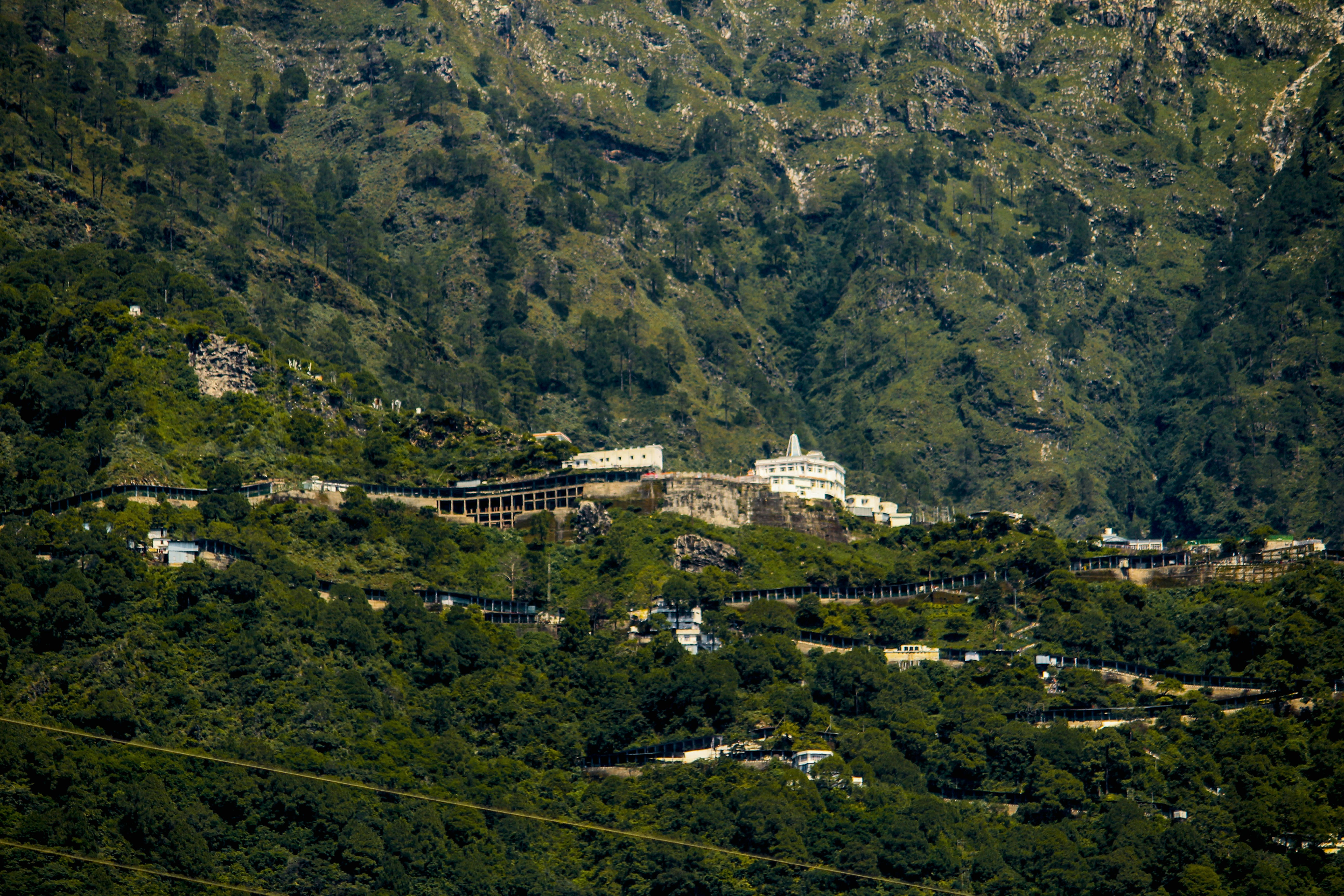A scenic view of a building on a mountain side photo – Free Land Image ...