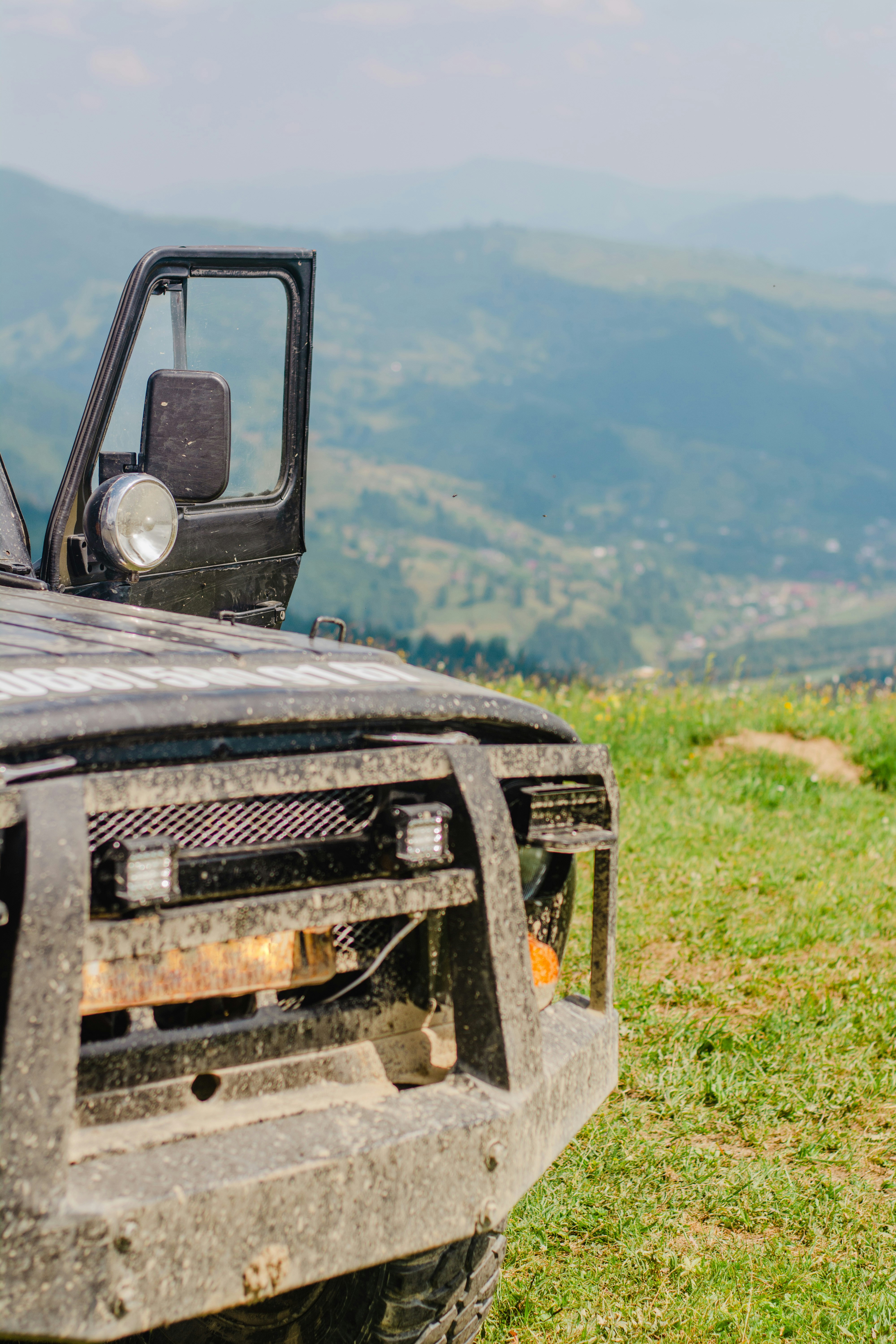 Frontier Grit: A weathered off-road rig guards the hillside panorama
