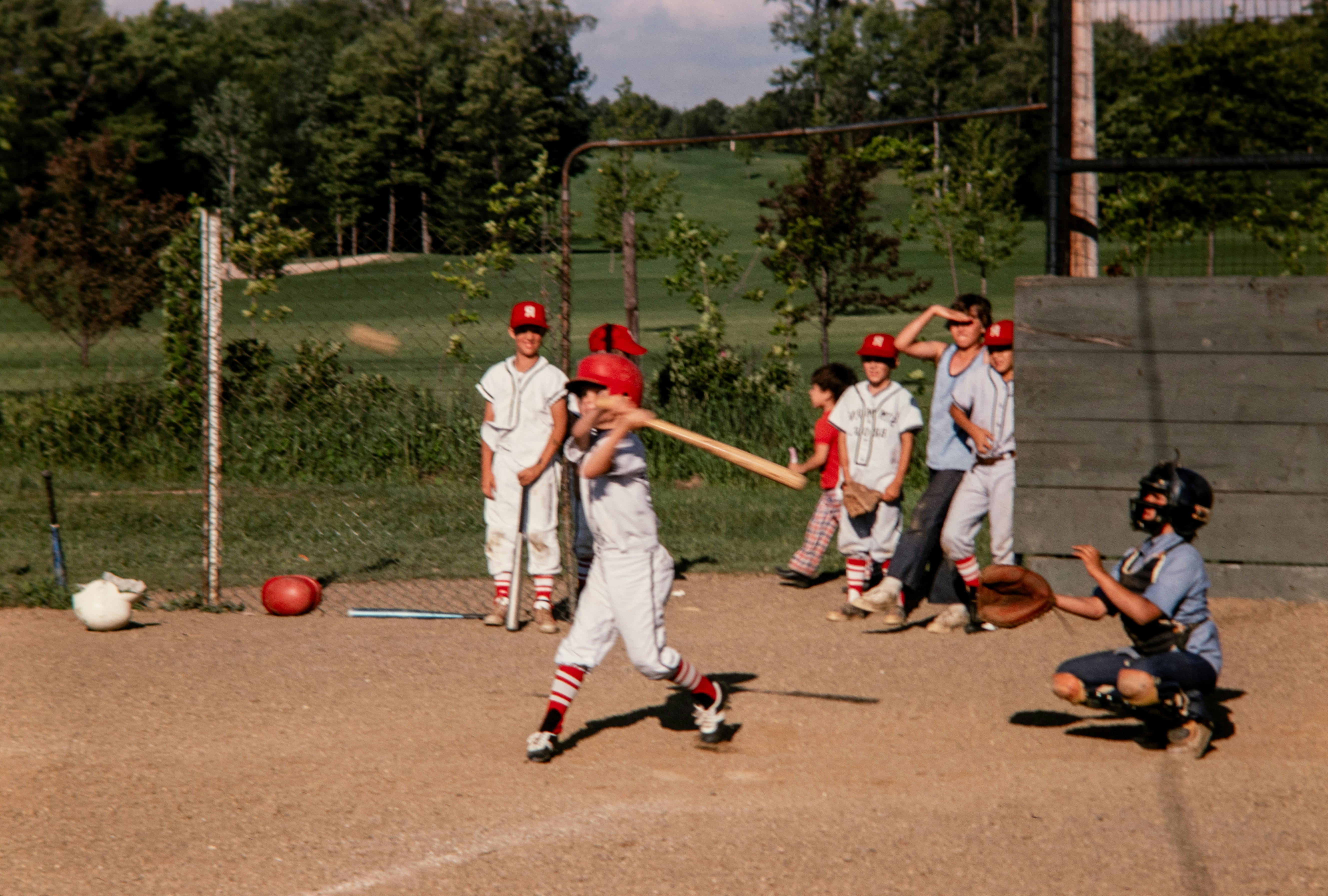 A group of young boys playing a game of baseball photo – Free Analog ...