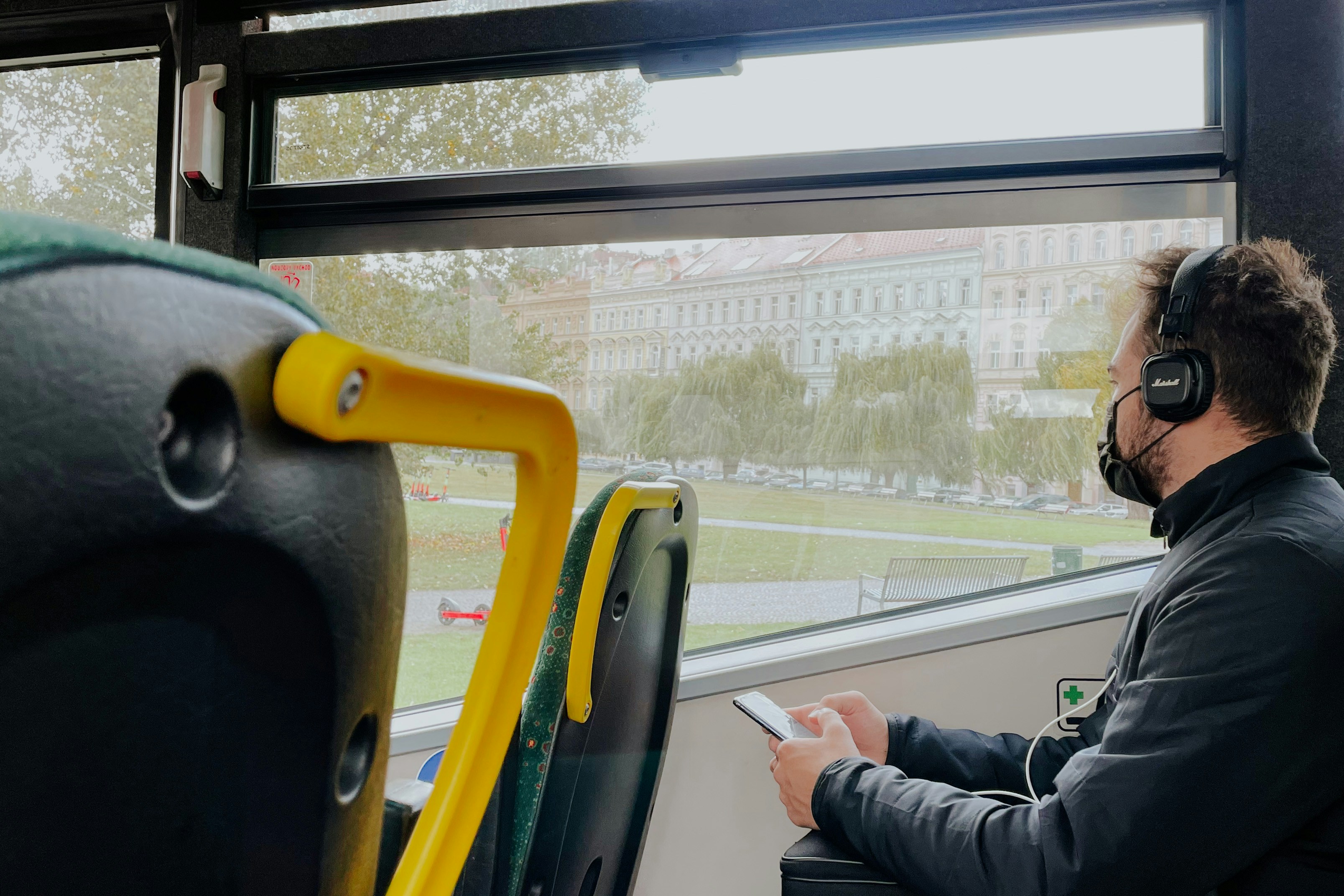 A man wearing headphones sitting on a bus photo – Free Prague Image on ...