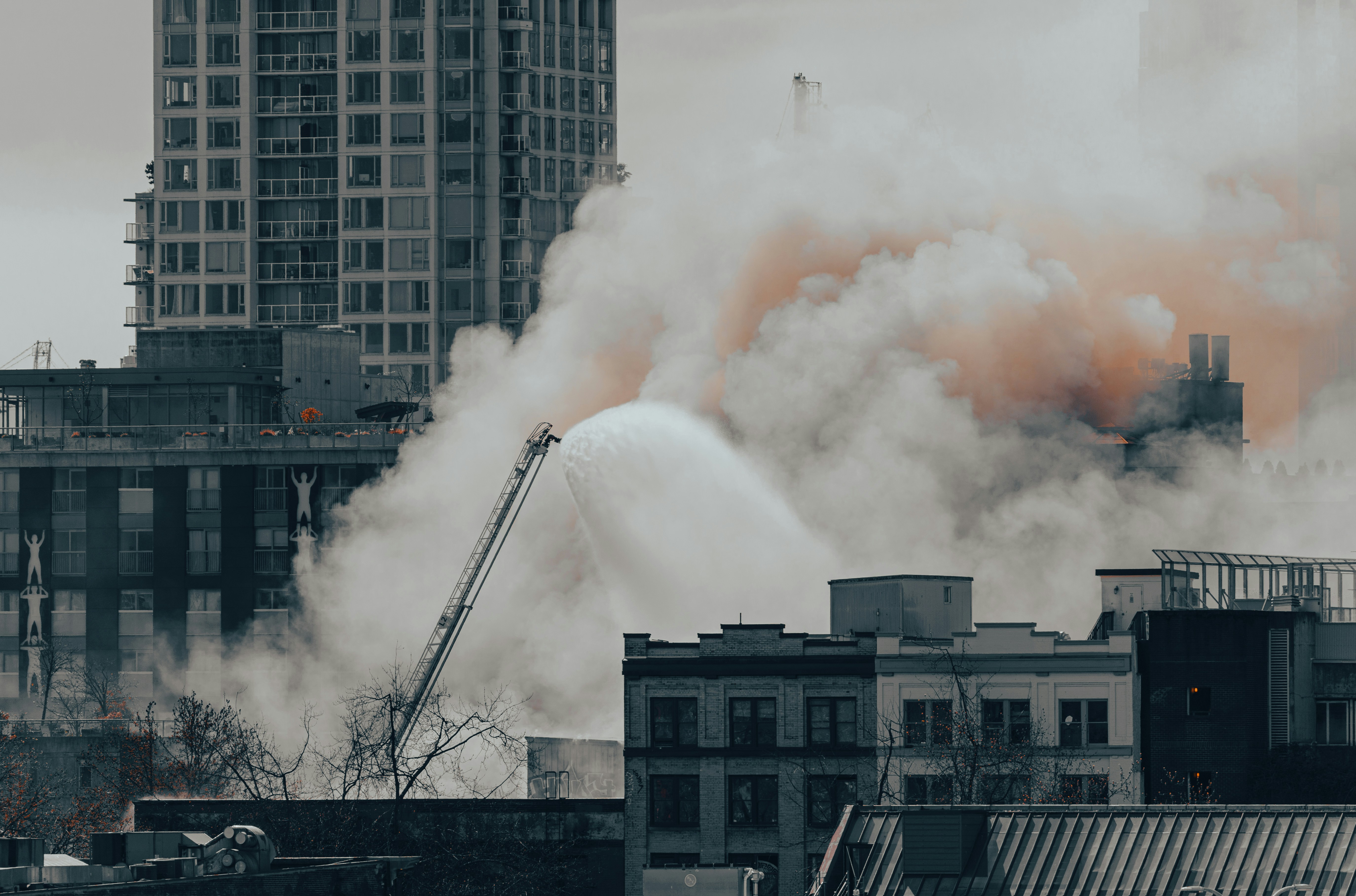 A large fire hydrant spewing water on top of a building photo – Free ...