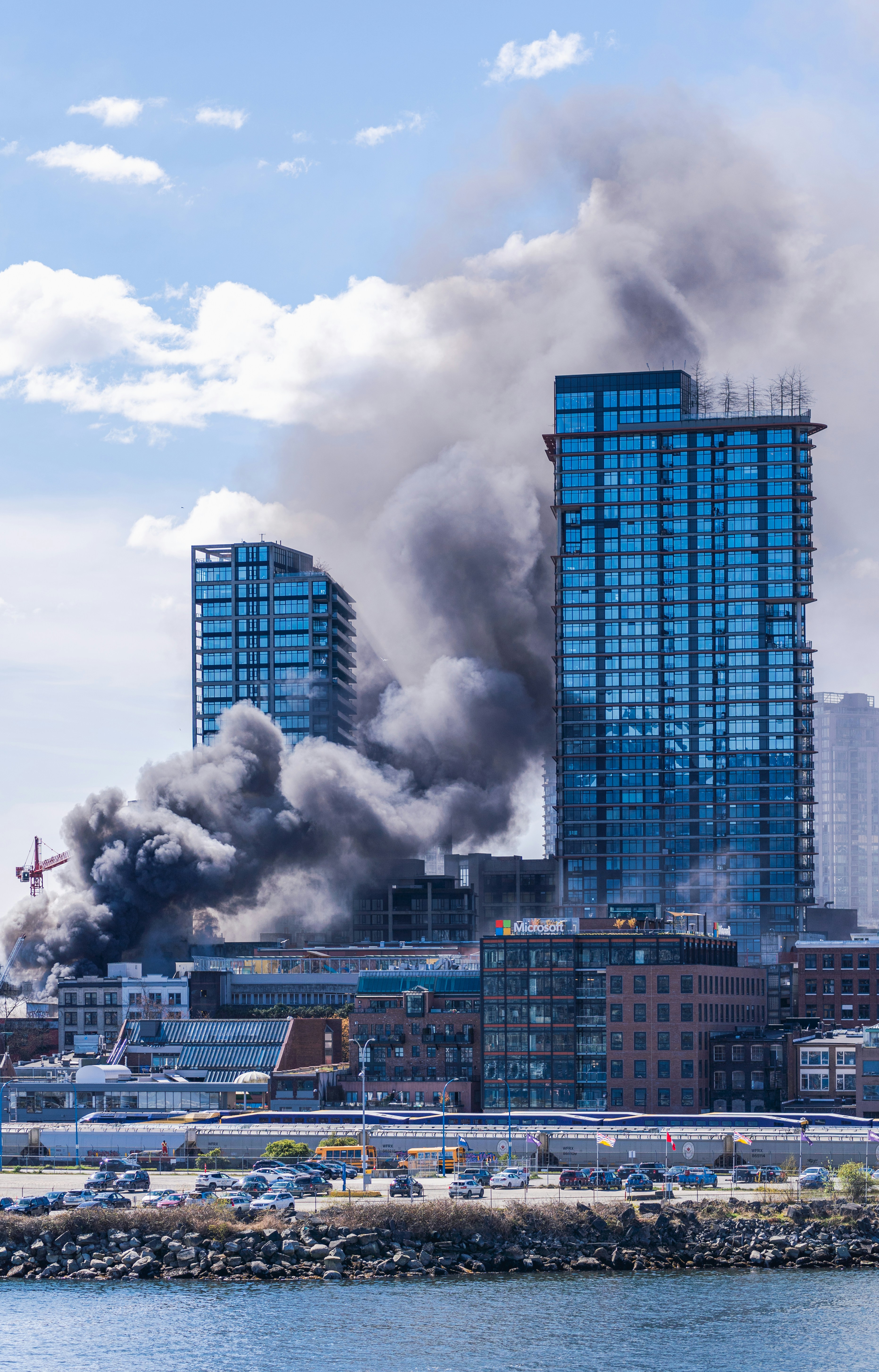 Towering Smoke: The Cityscape Confronts a Rising Cloud