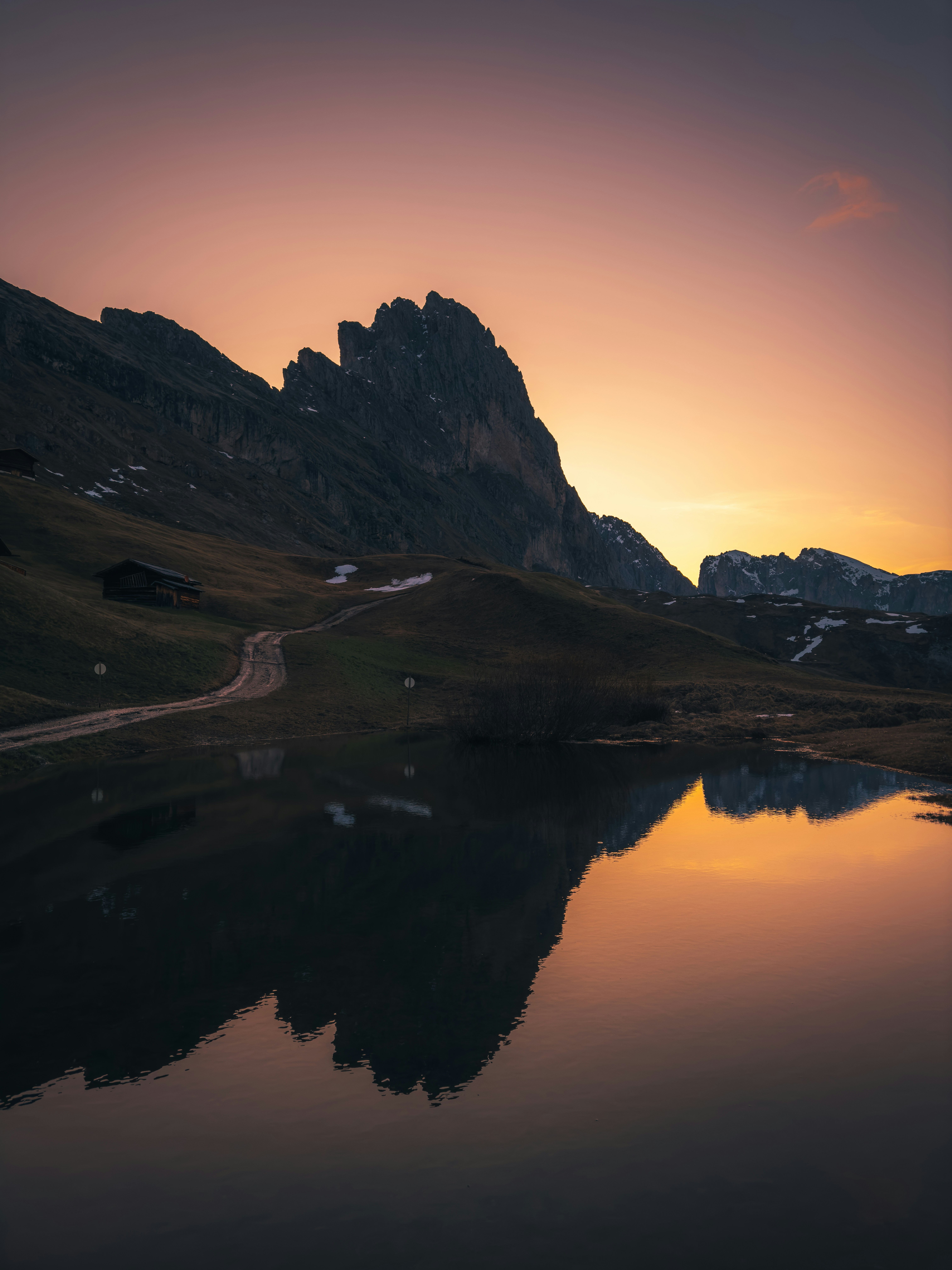 A mountain range with a lake in the foreground photo – Free Seceda ...