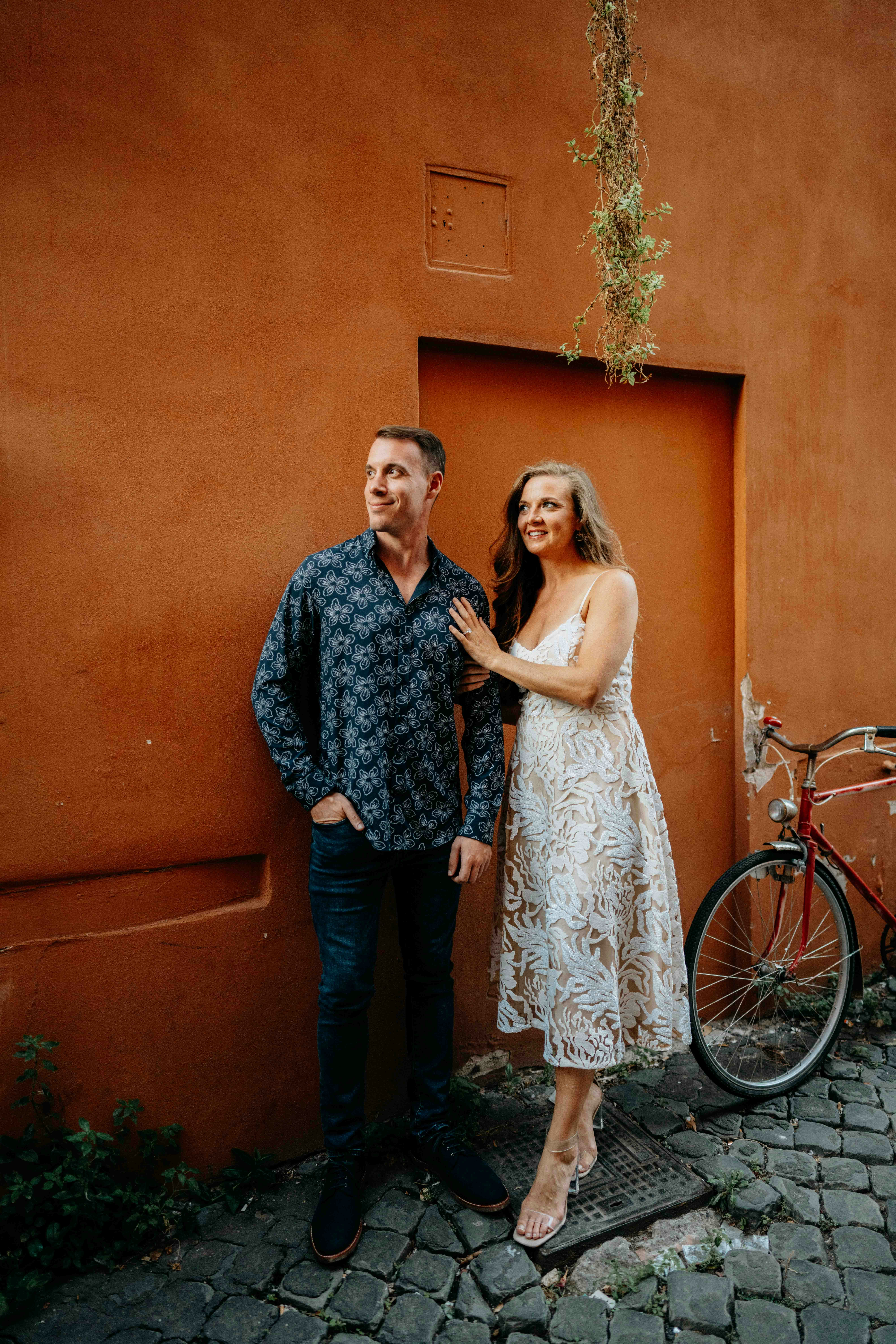Couple in a sunlit alley: a moment by the ochre wall