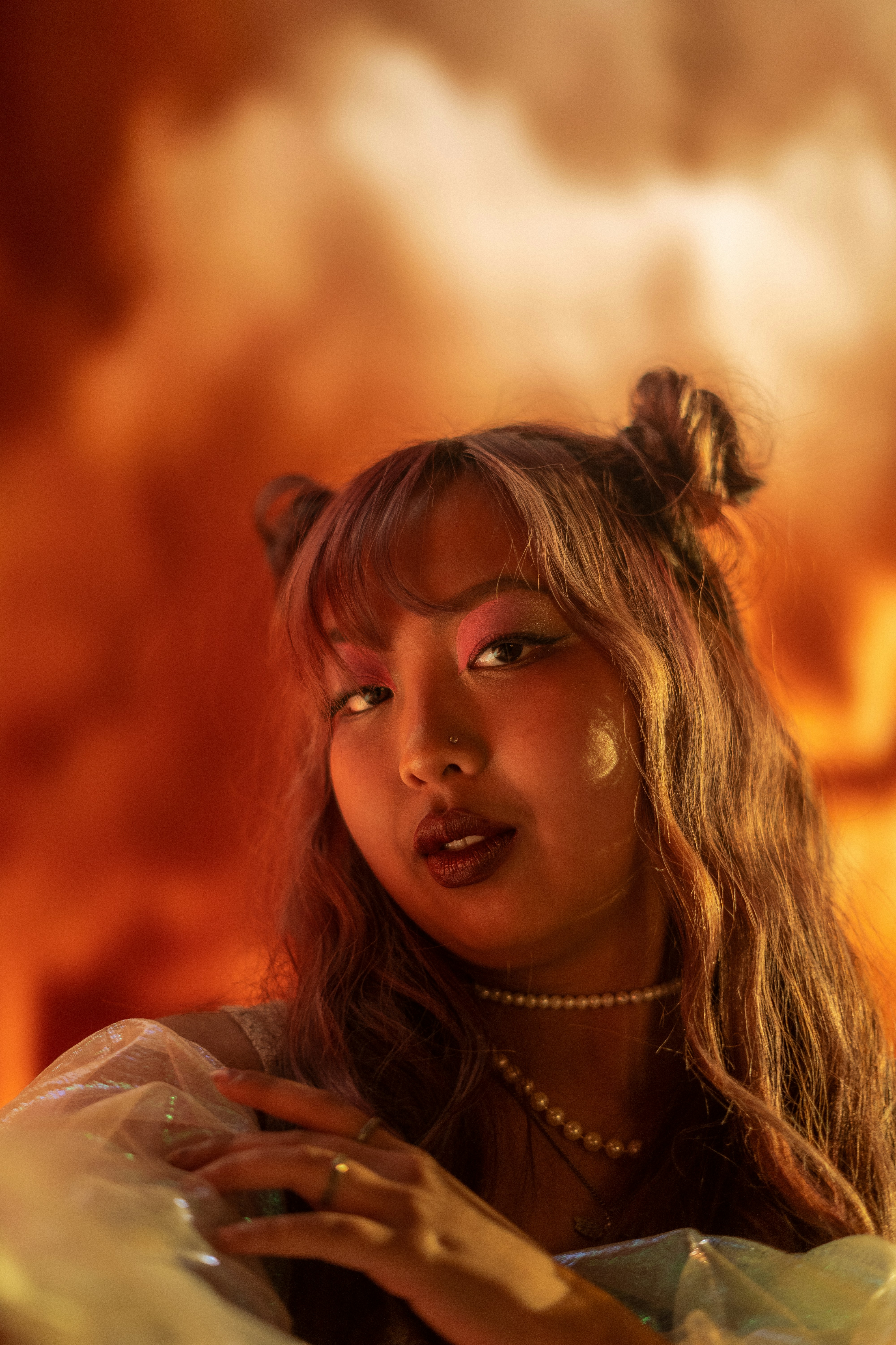Amber Firelight Portrait: Velvet-Eyed Muse with Space Buns