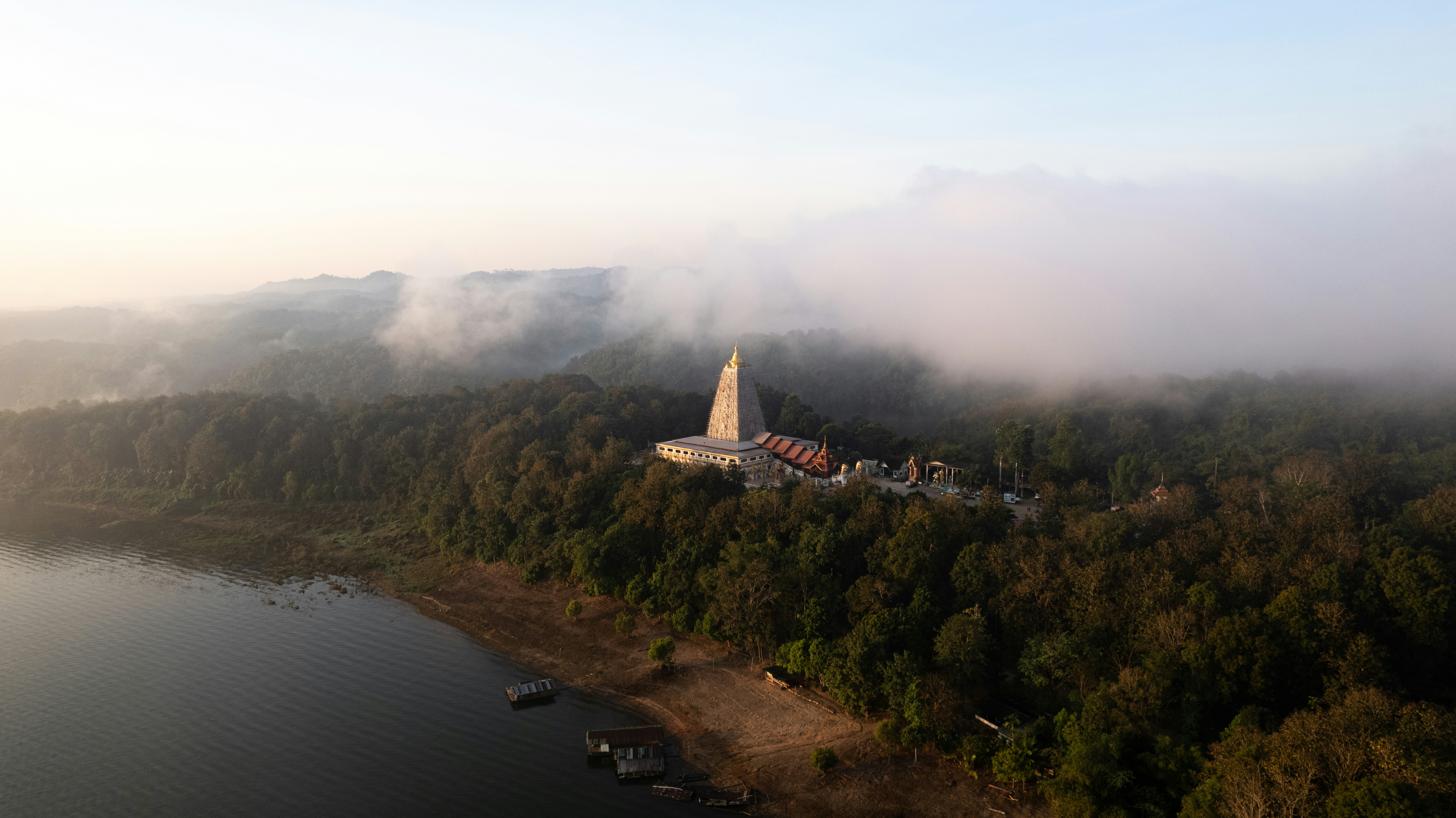 Spire in the Mist: A Hilltop Church Over Lake and Forest