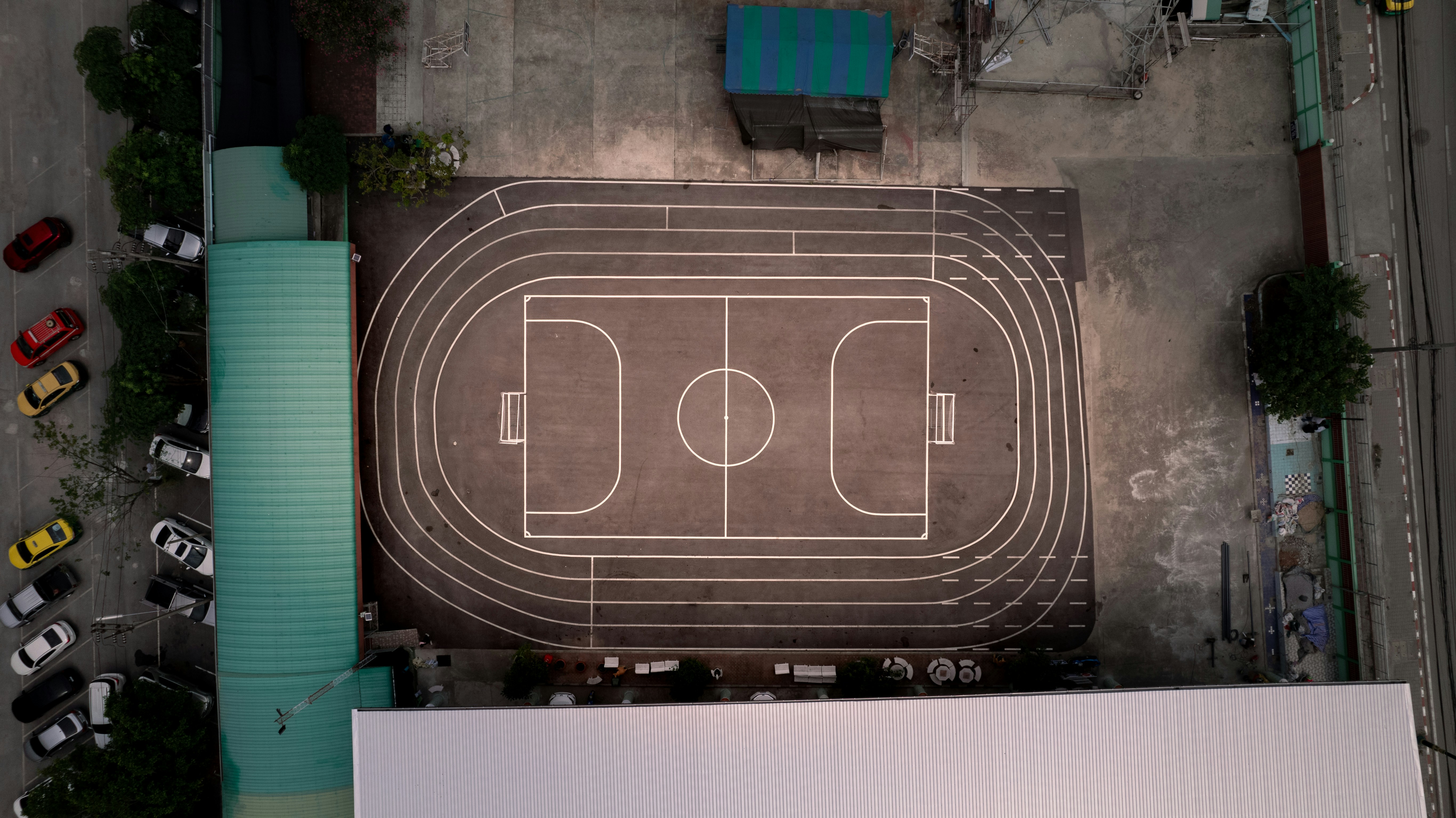 an aerial view of a basketball court in a parking lot