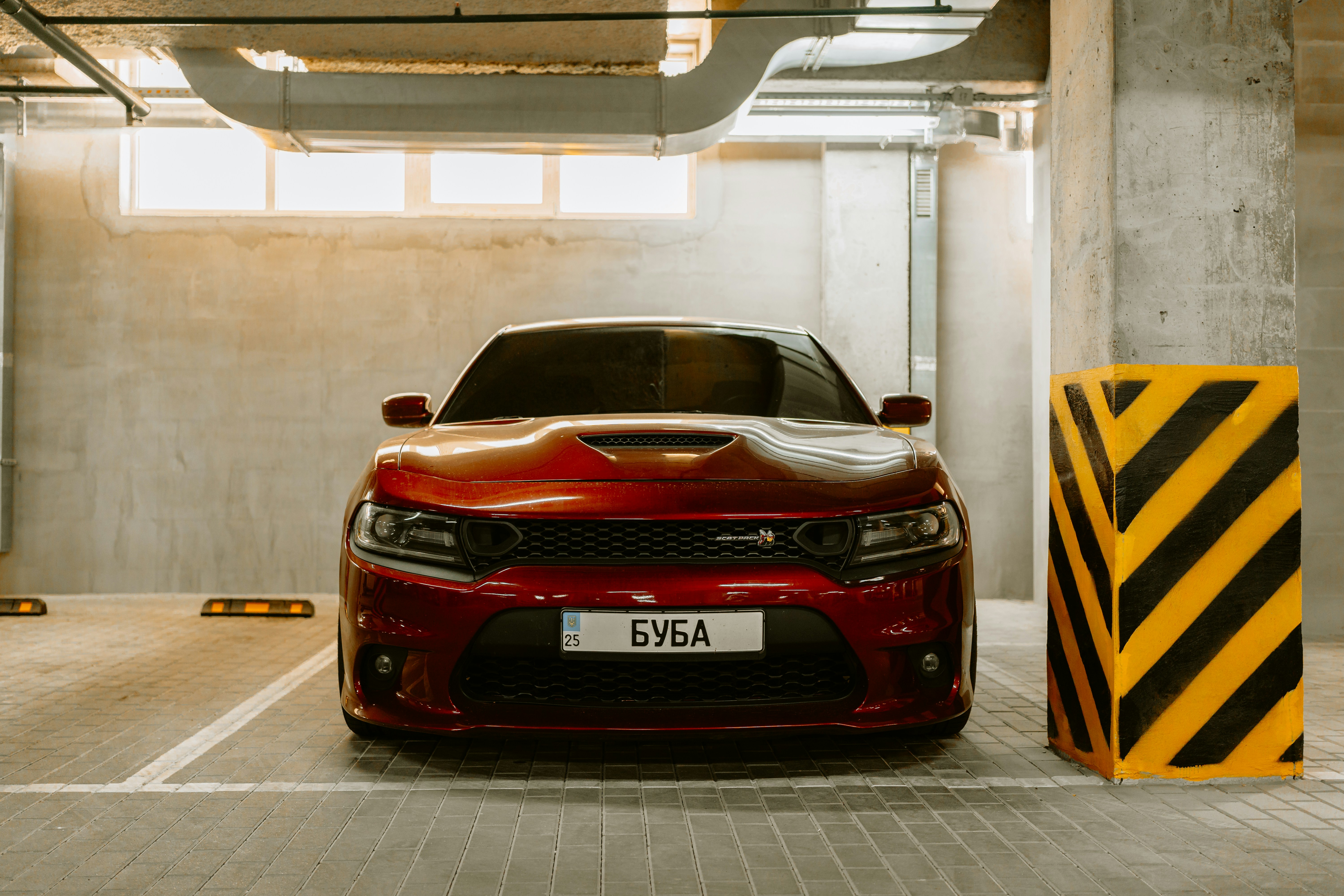 A red car parked in a parking garage photo – Free Kyiv Image on Unsplash
