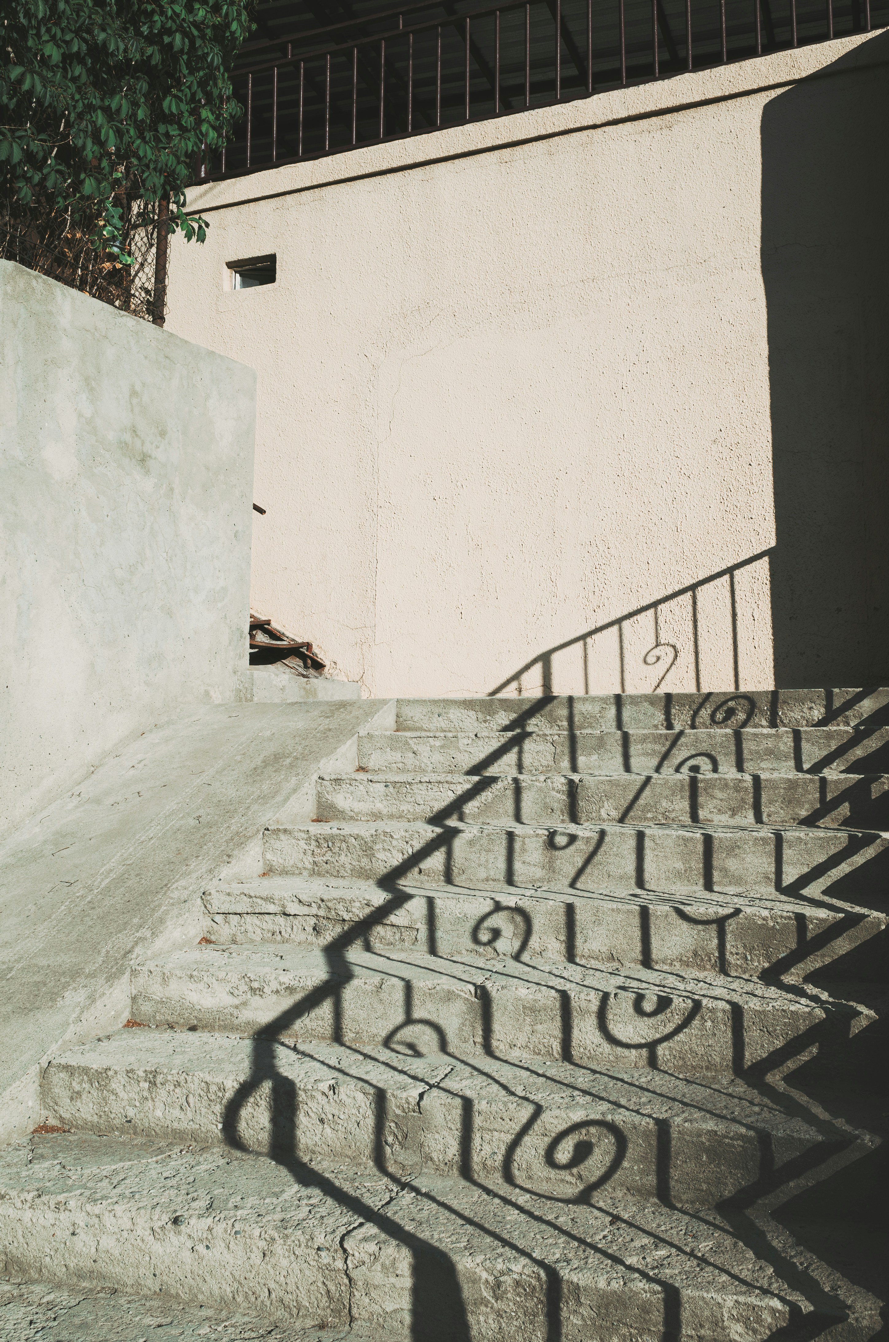 Shadowed Staircase Echoes: Spirals of Light on Concrete Steps