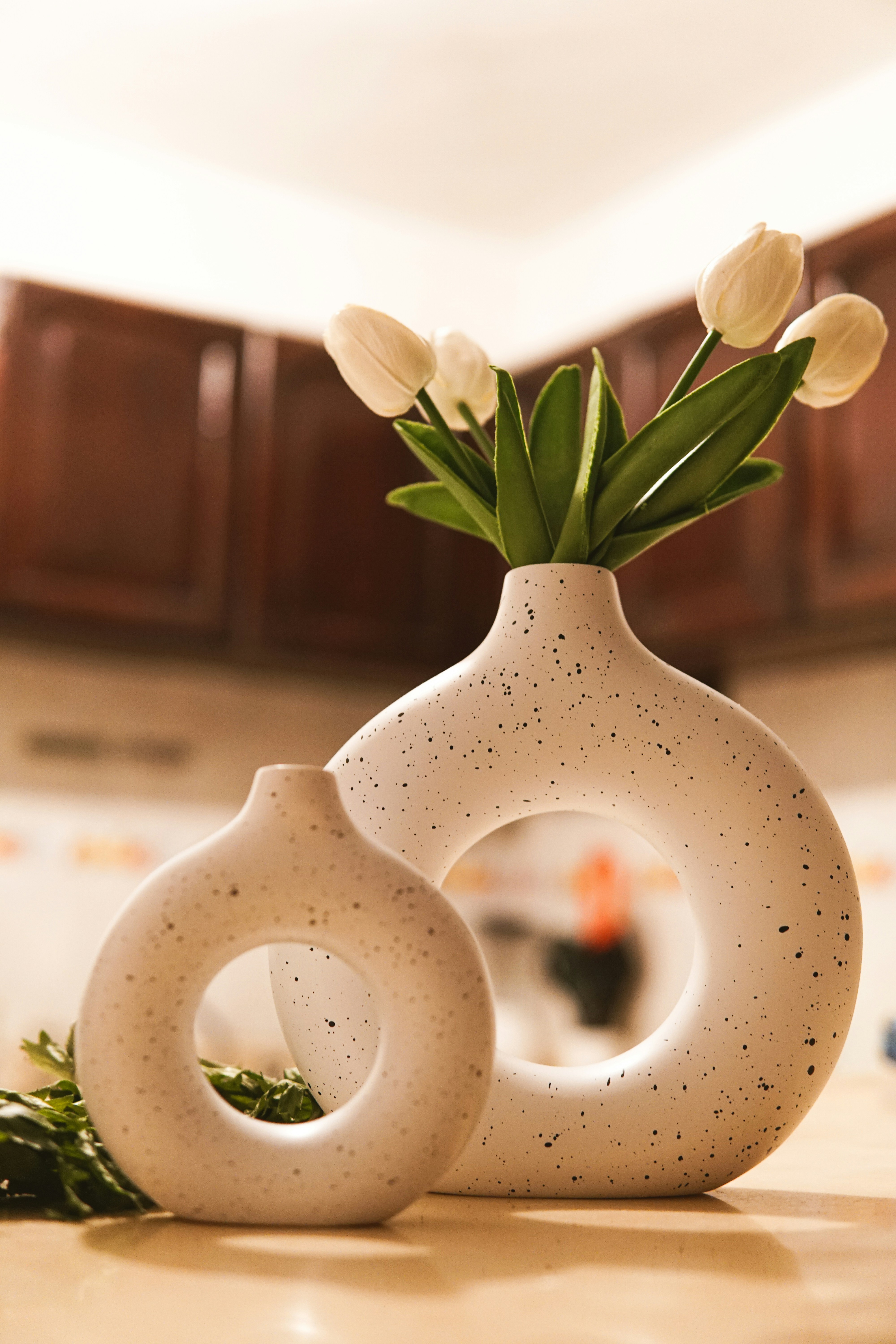 Pebble-Speckled Orbs Cradle Tulips in Warm Kitchen Glow