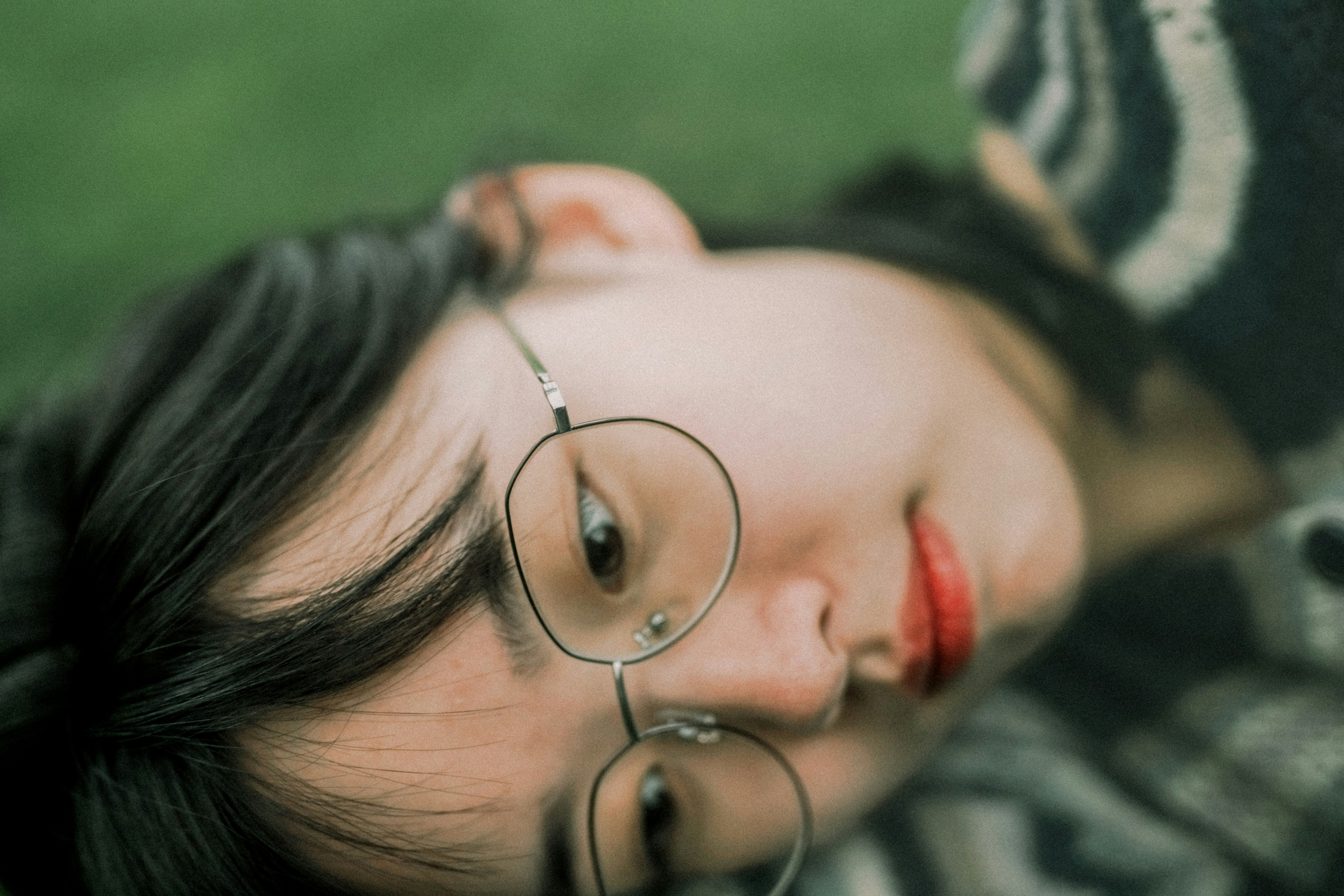 Gaze Through Round Glasses on a Grass-Soft Portrait