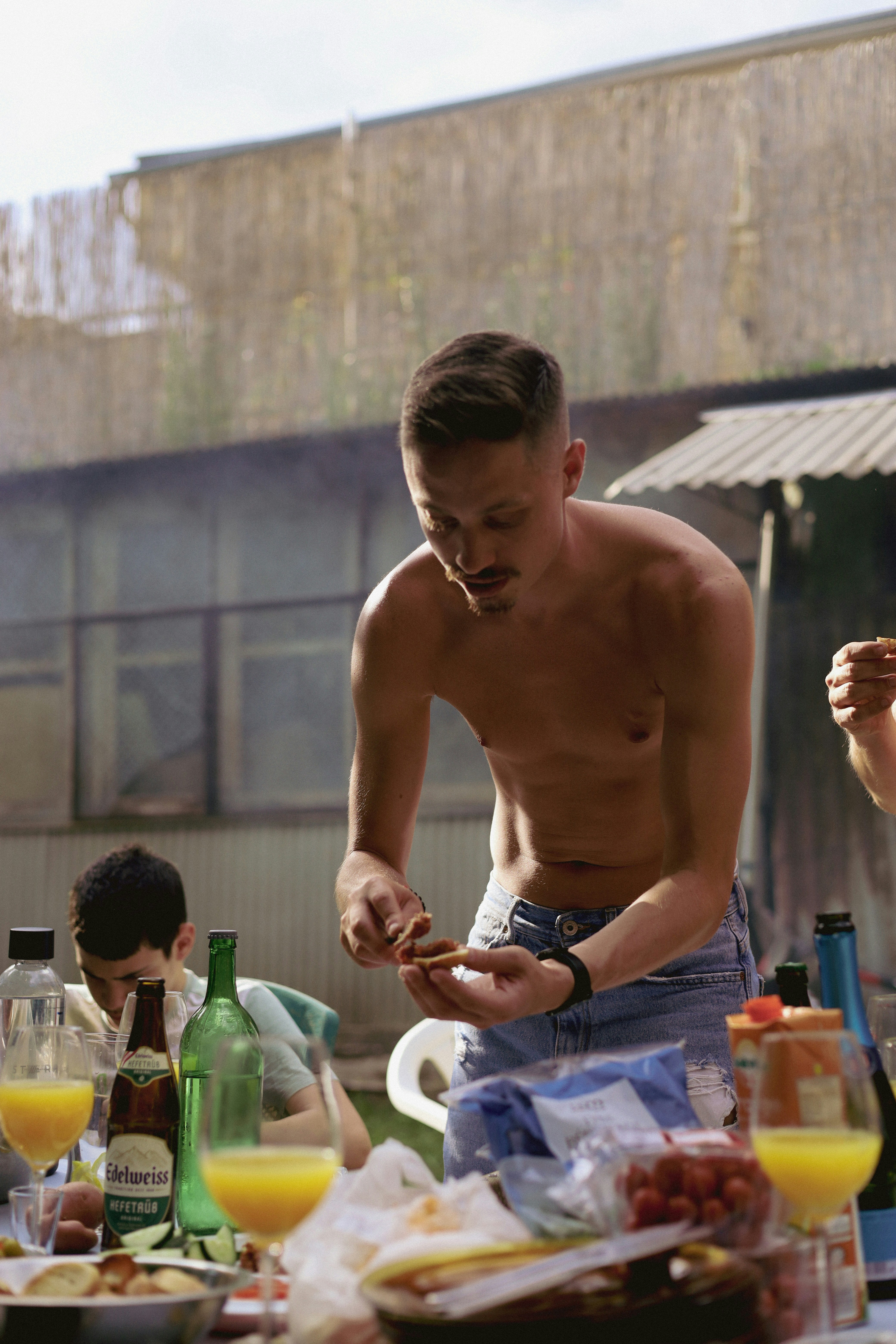 Midday Grill Master: a lean host carving moments at a sunlit backyard feast