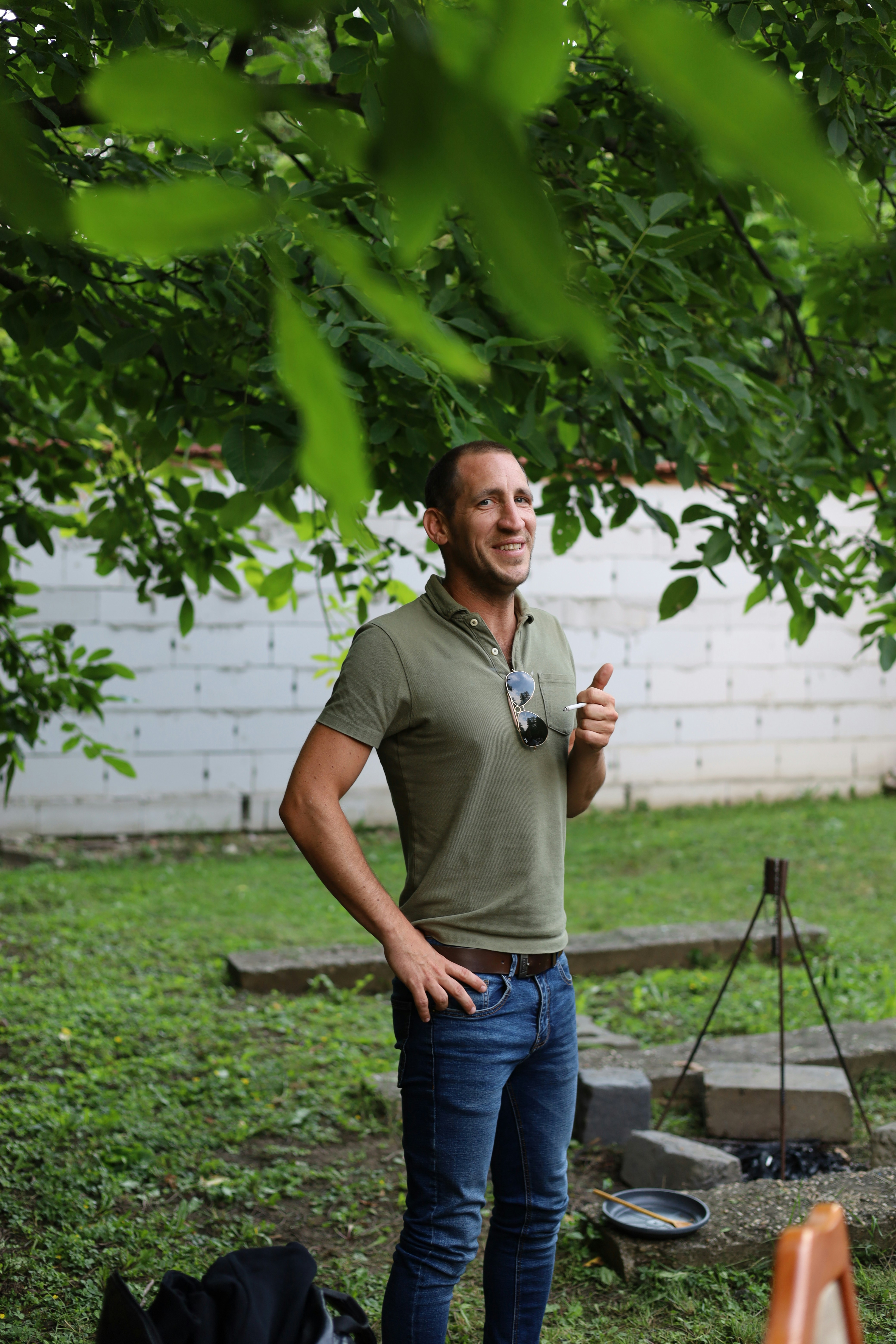 A man standing under a tree with his hands on his hips photo – Free ...