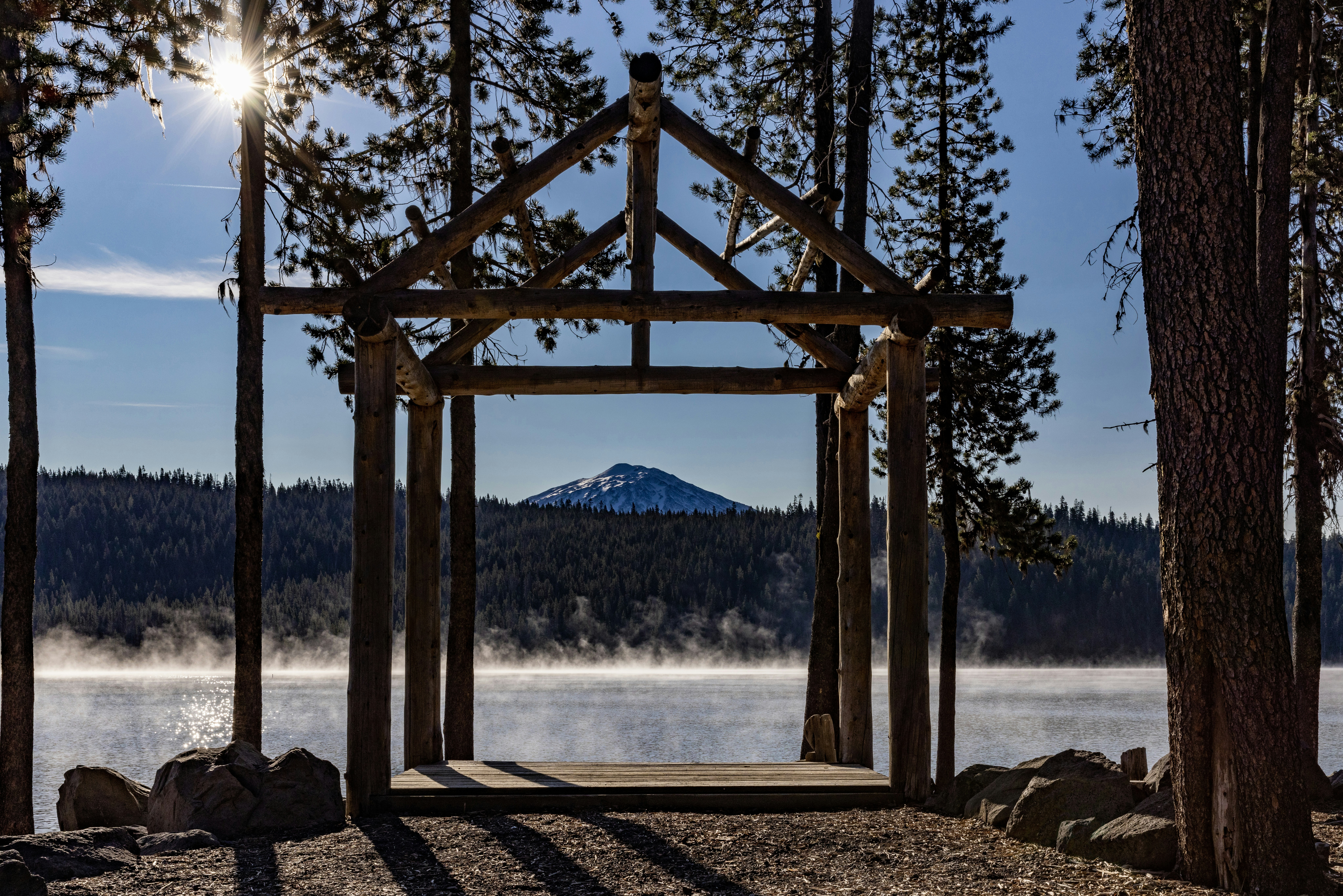 Timber Portal to a Misty Lake and Snowbound Peak