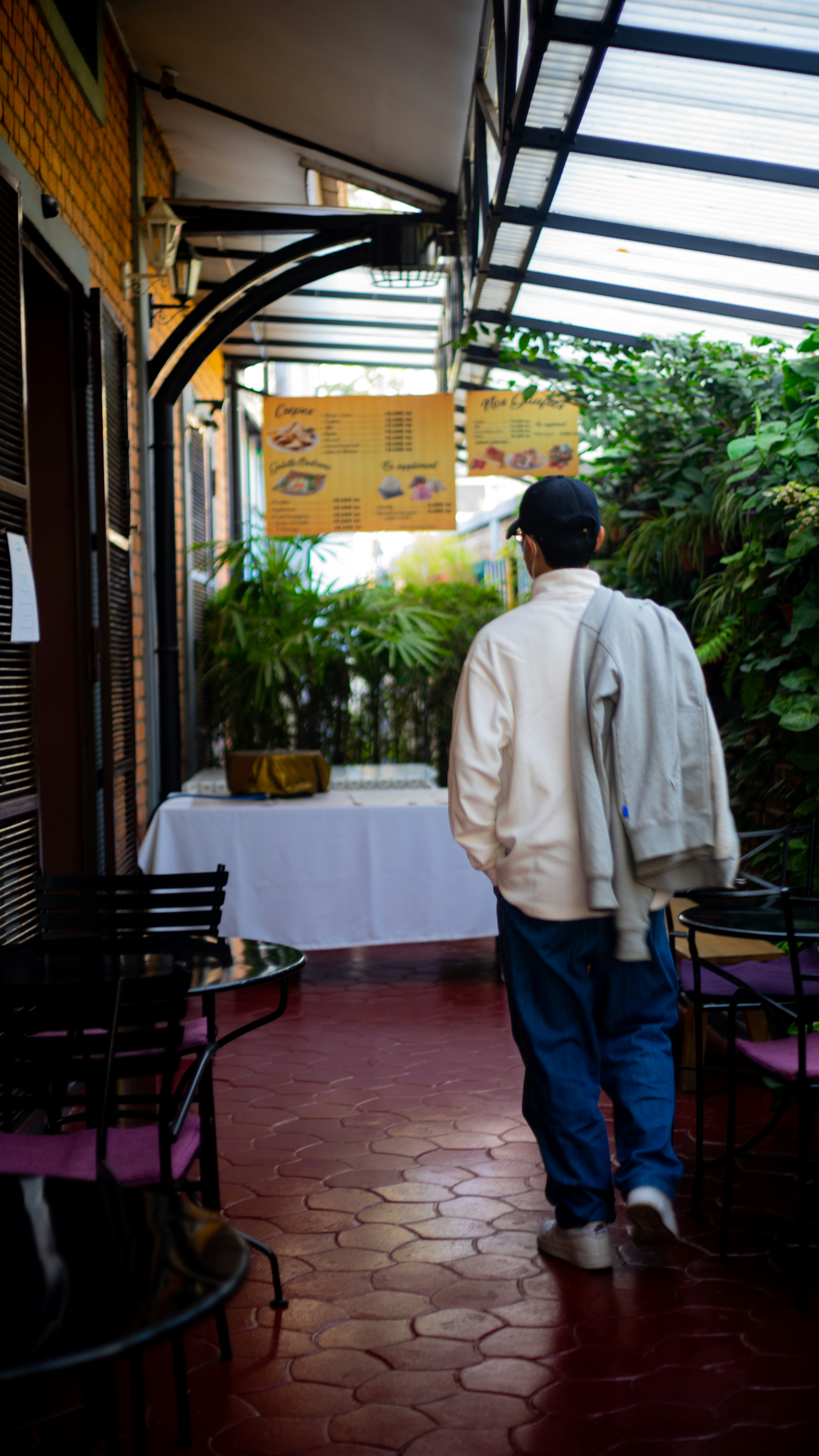 Back-turned Moment: White-Jacket Stroll Past Café Menu Boards
