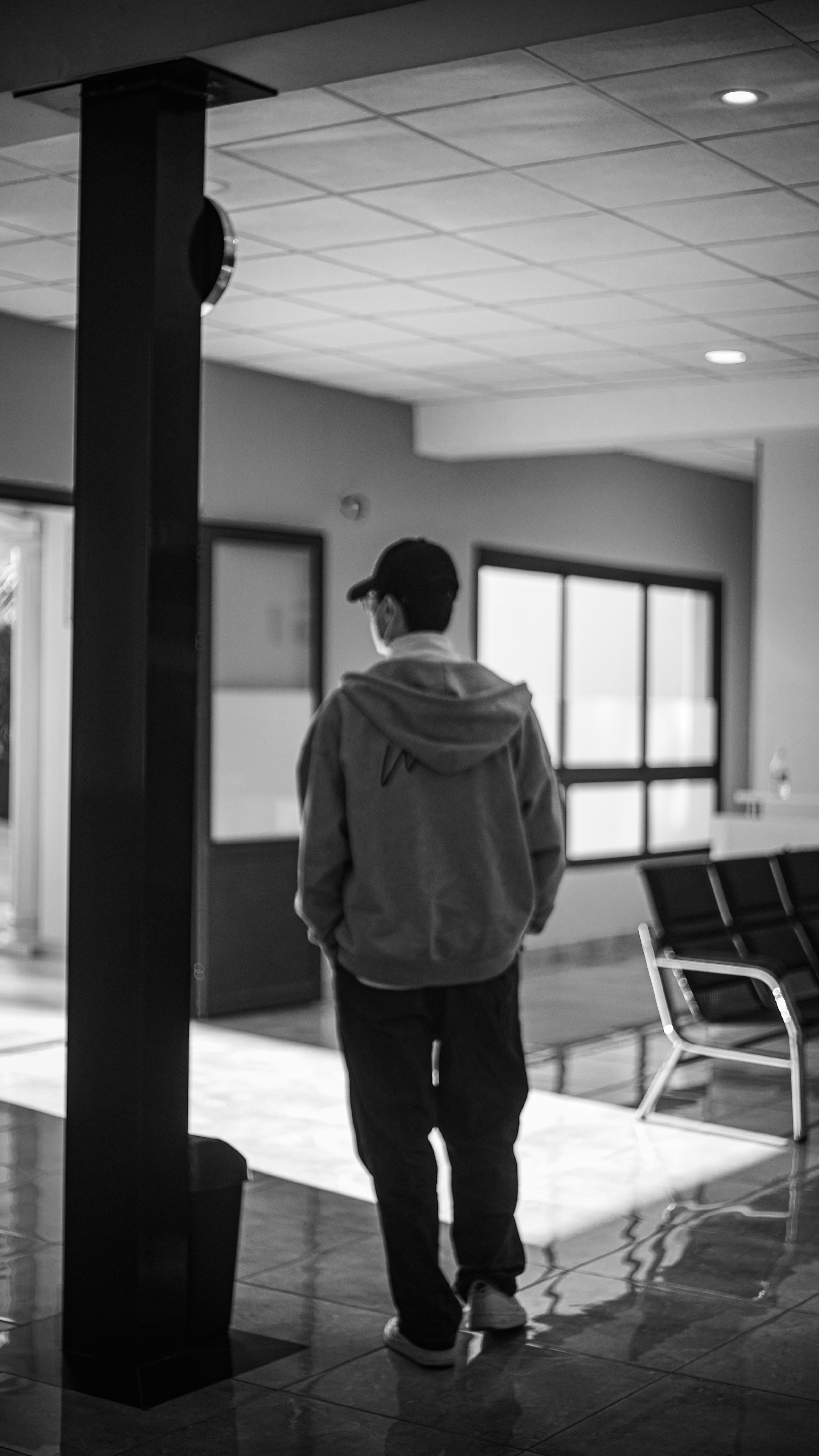 Behind the Glass Corridor: A Quiet Moment in Gray
