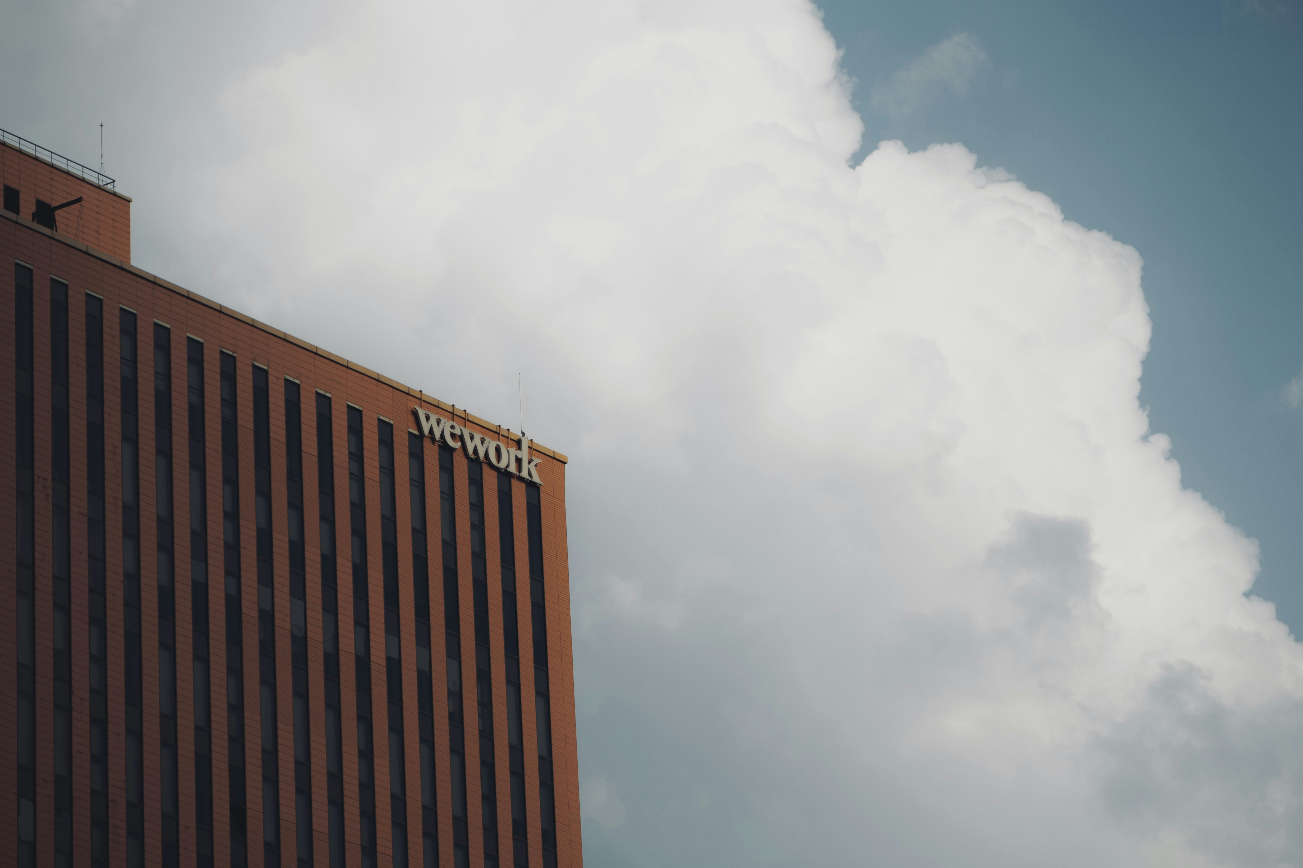 WeWork Sign Against a Cloud-Swept Skyline