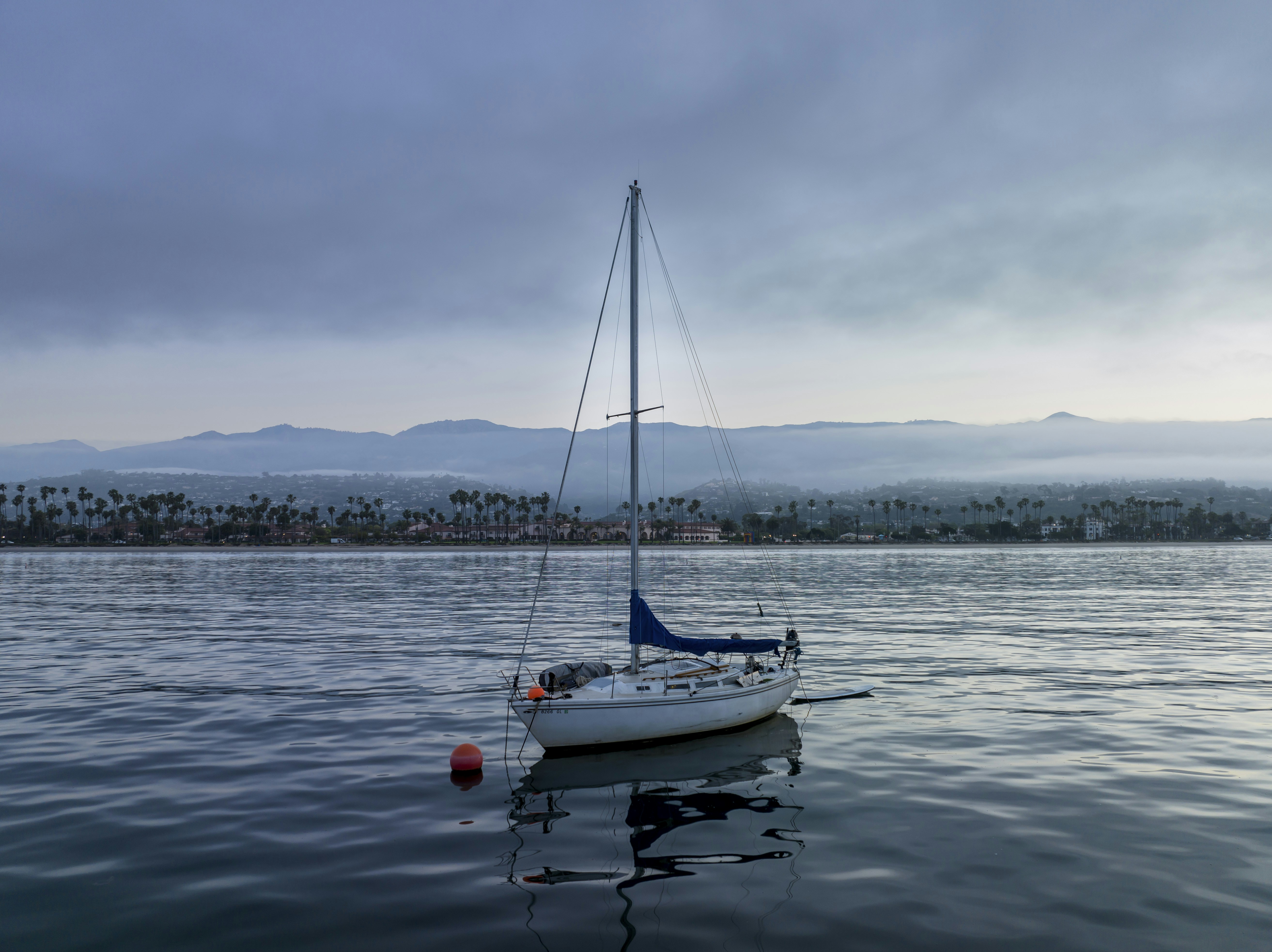 A sailboat floating on top of a body of water photo – Free Boat Image ...