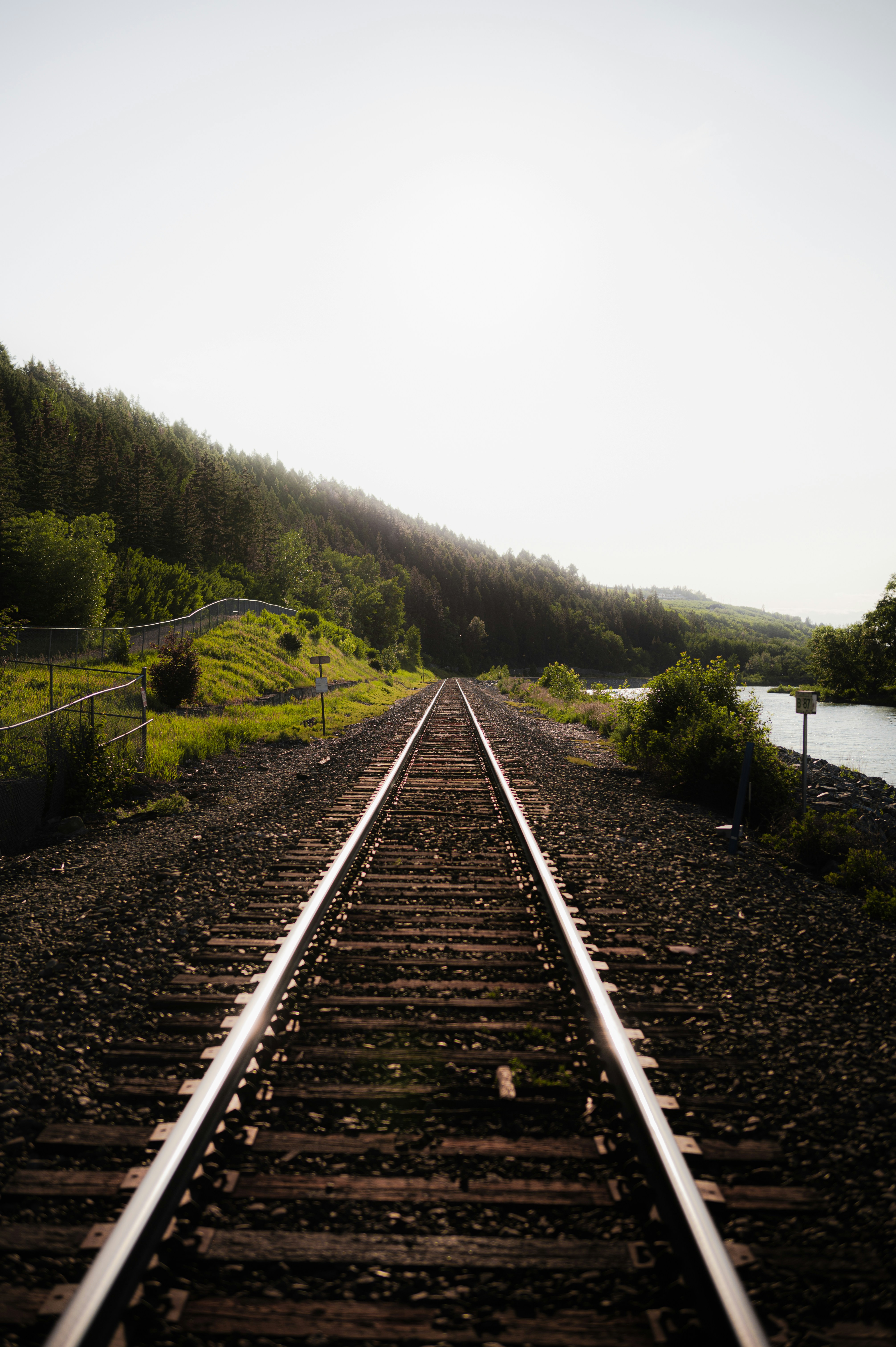 A train track running through a lush green countryside photo – Free ...