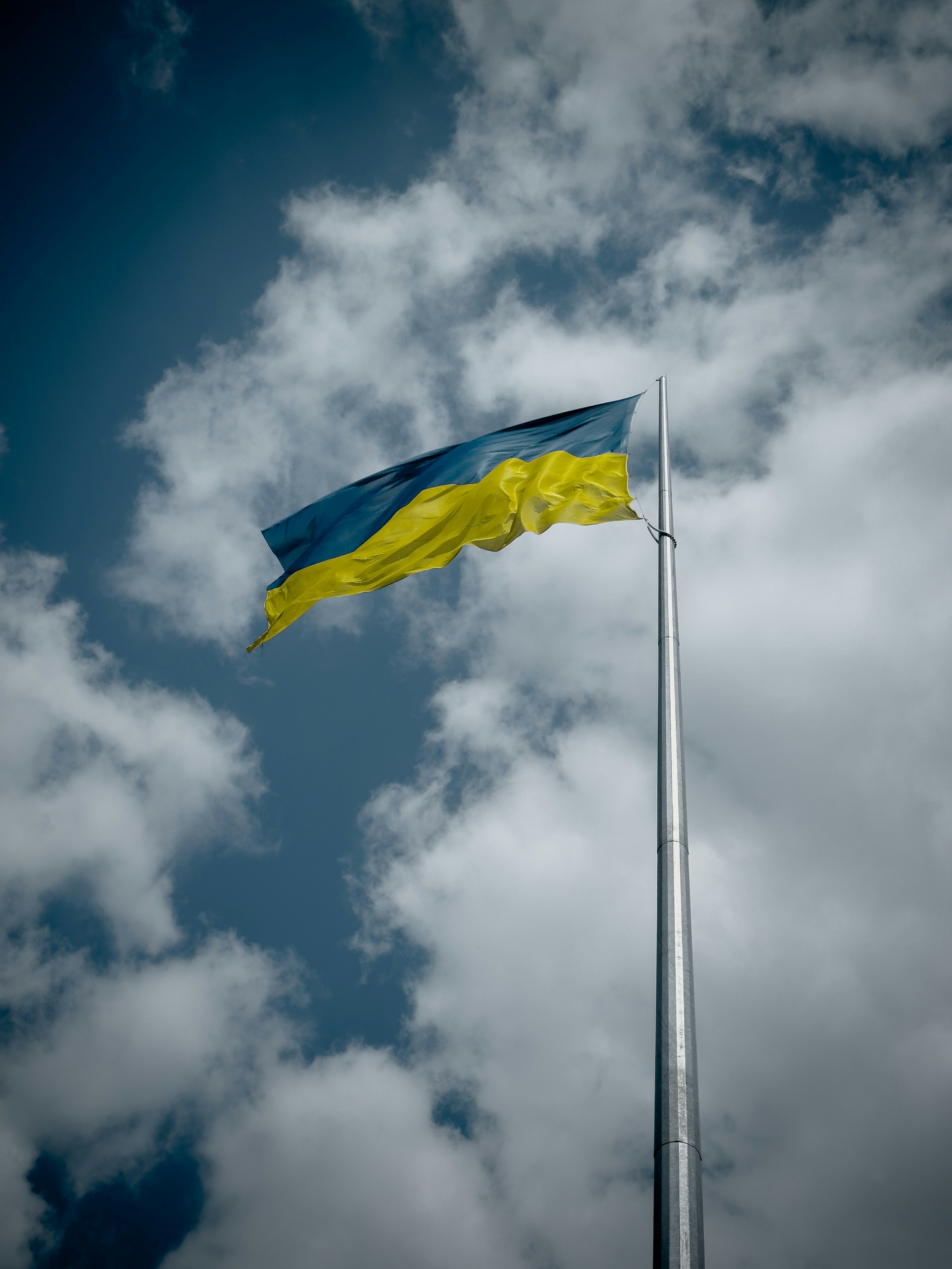 A yellow and blue flag is flying high in the sky photo – Free Brovary ...
