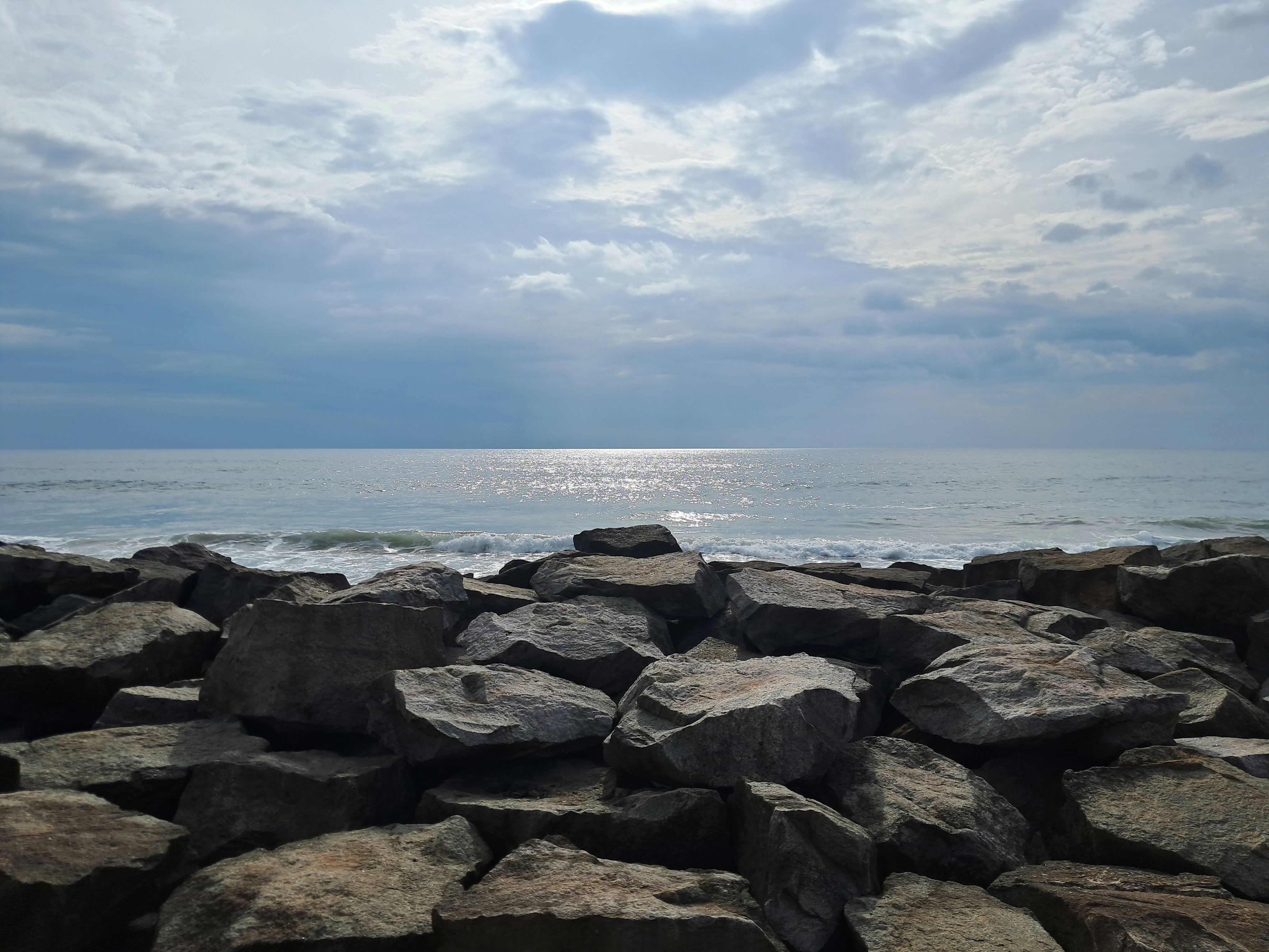 A bunch of rocks that are by the water photo – Free Varkala Image on ...