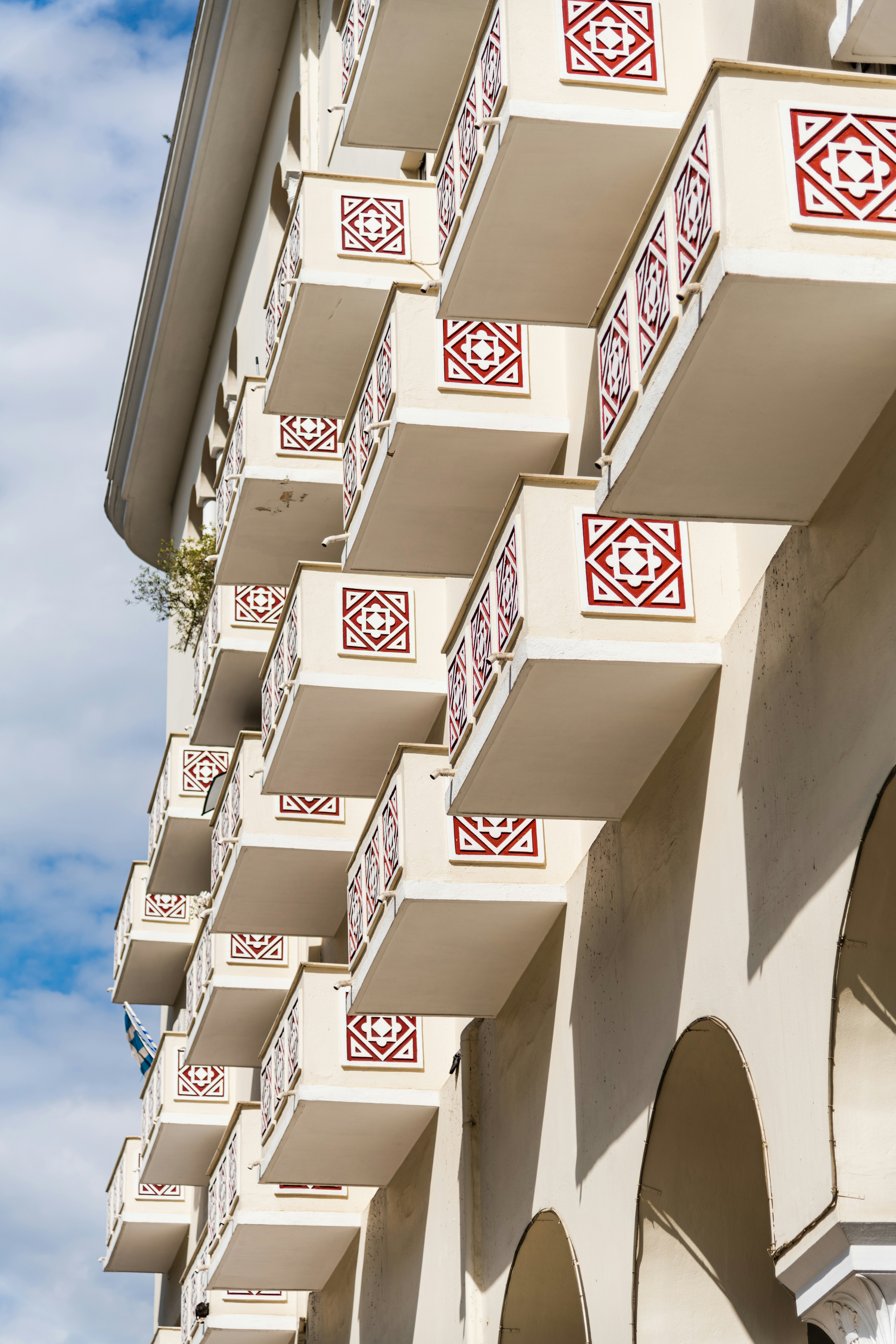 Geometric Echoes on a Cream Facade: A Diagonal Ballet of Balconies