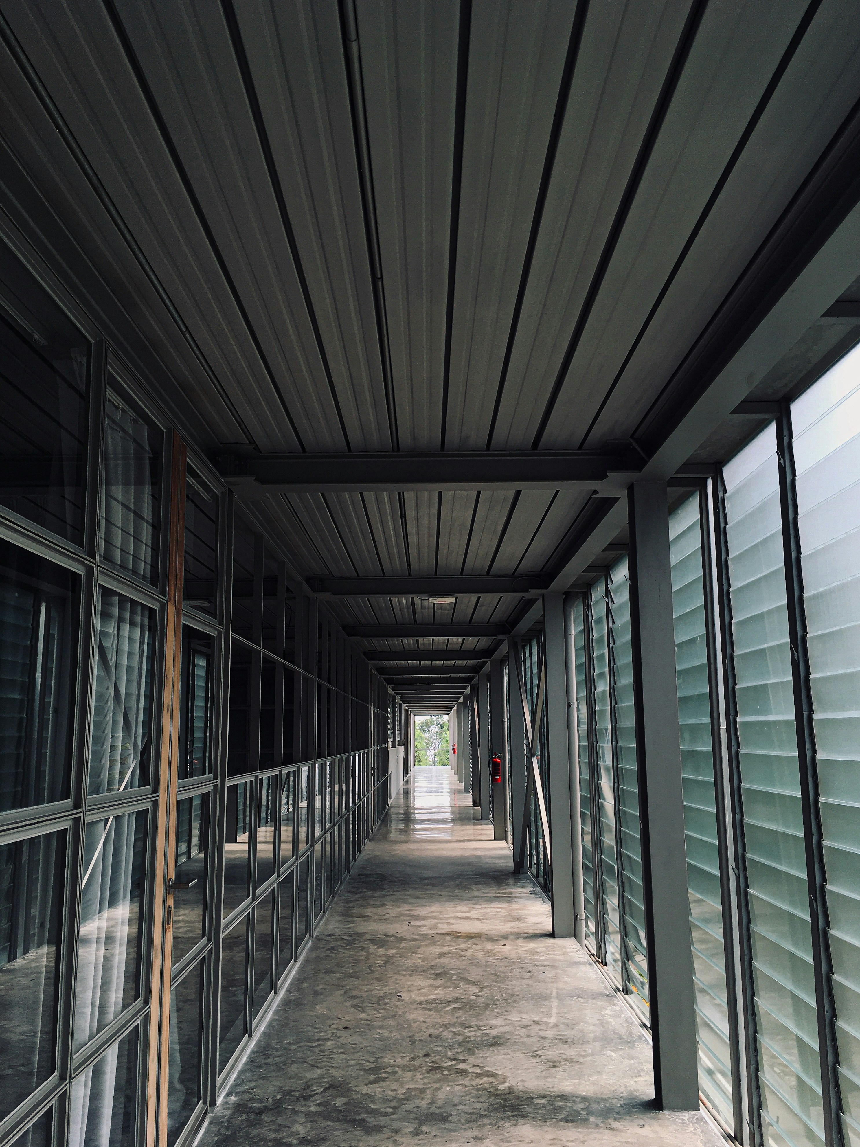 A long walkway lined with lots of windows photo – Free Building Image ...
