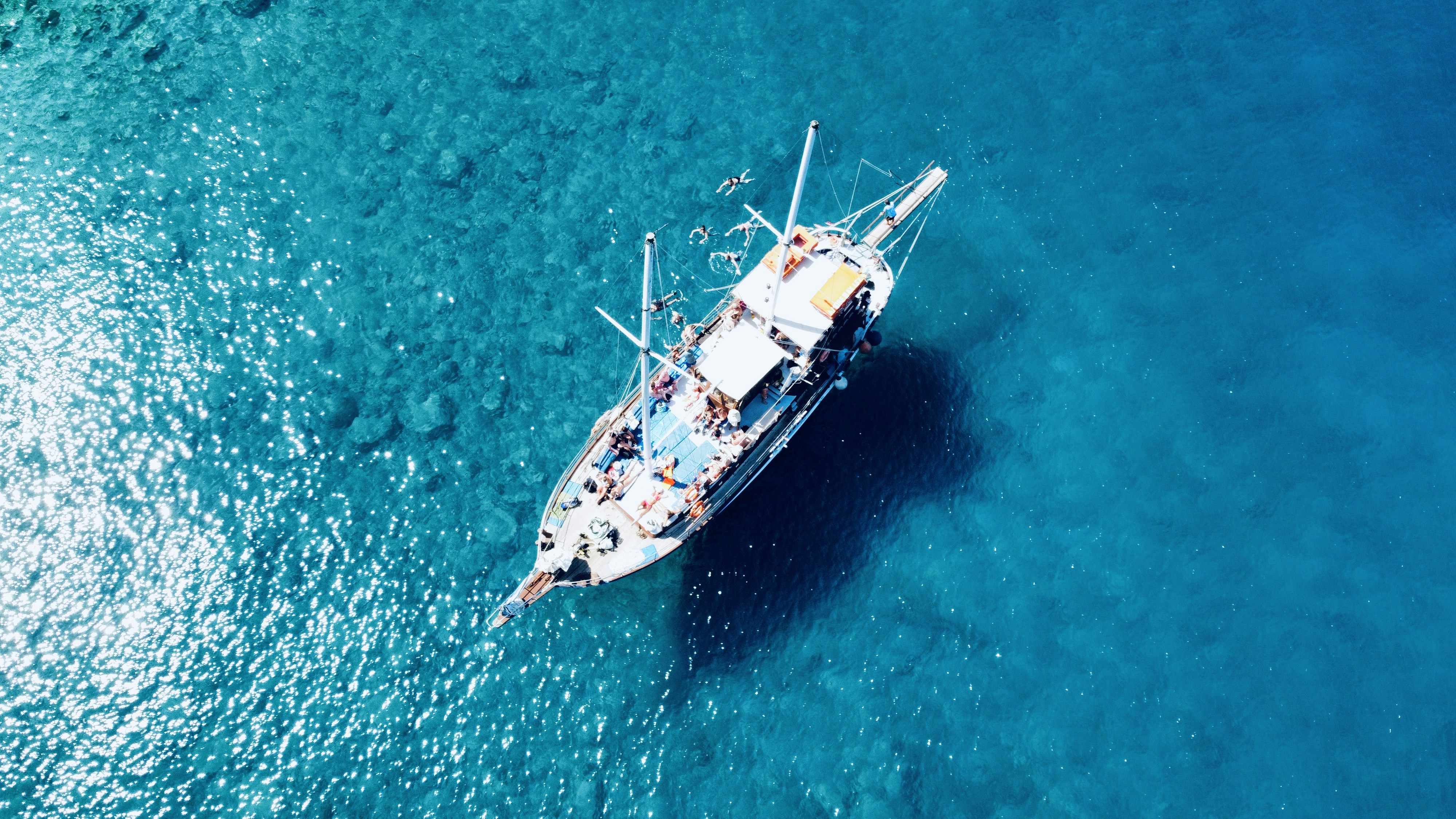 A boat floating on top of a body of water photo – Free Greece Image on ...
