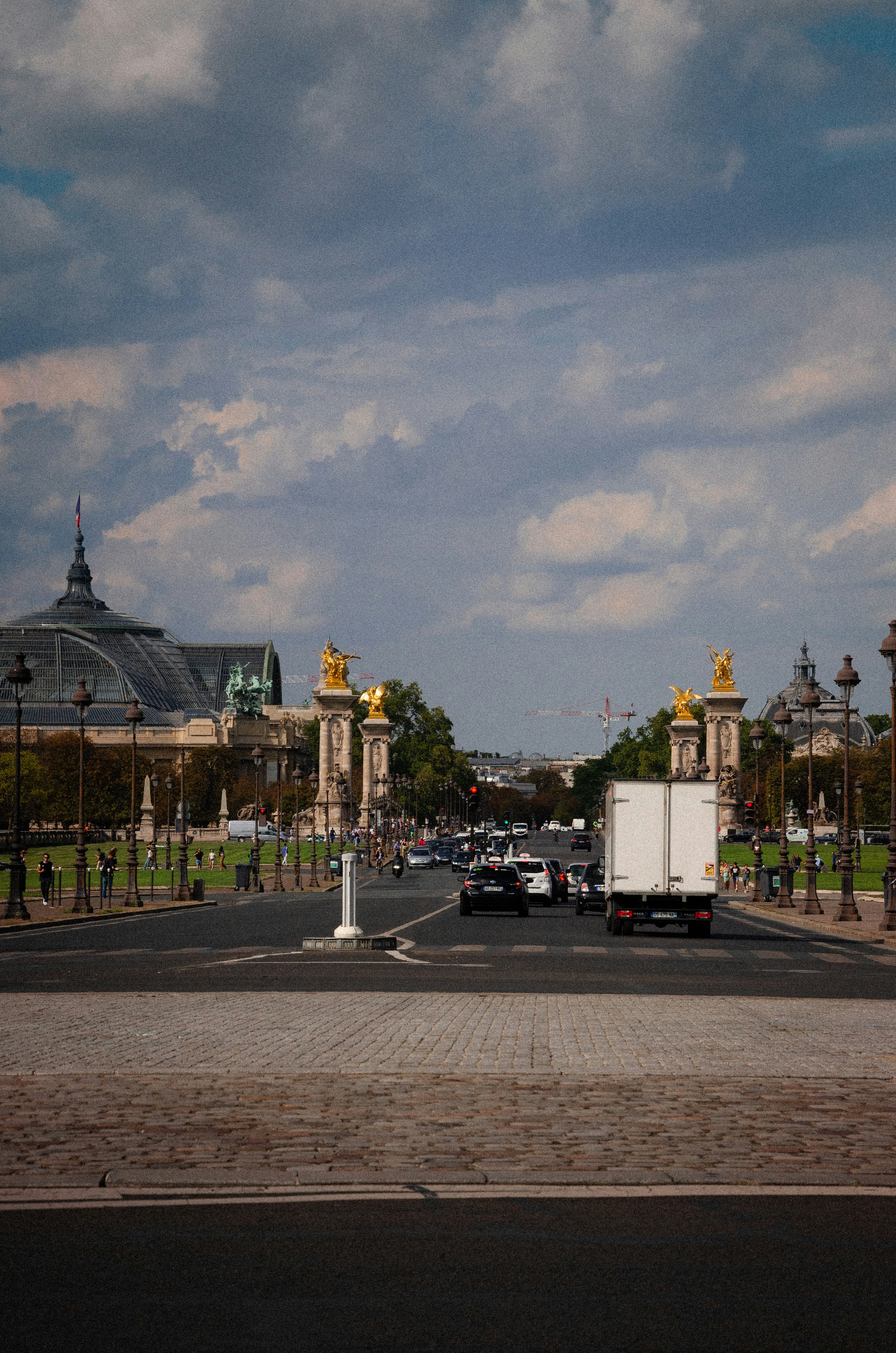 Golden Gatekeepers Over a Parisian Boulevard on Pont Alexandre III