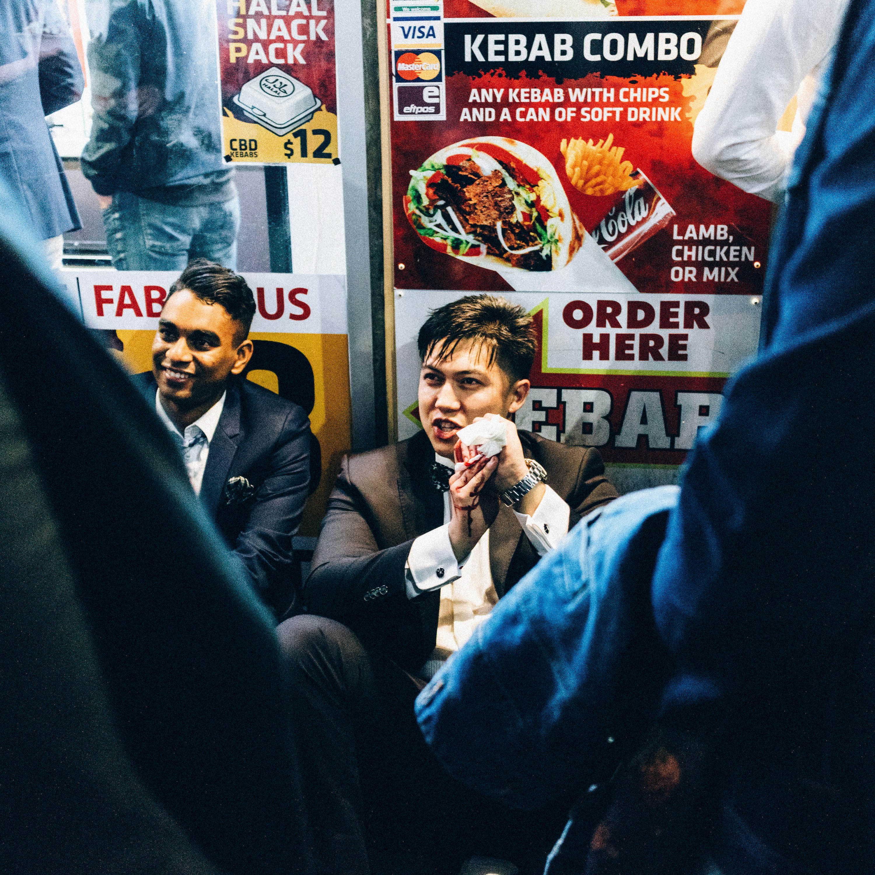 Suits and Neon: A Quiet Pause Behind Kebab Signs