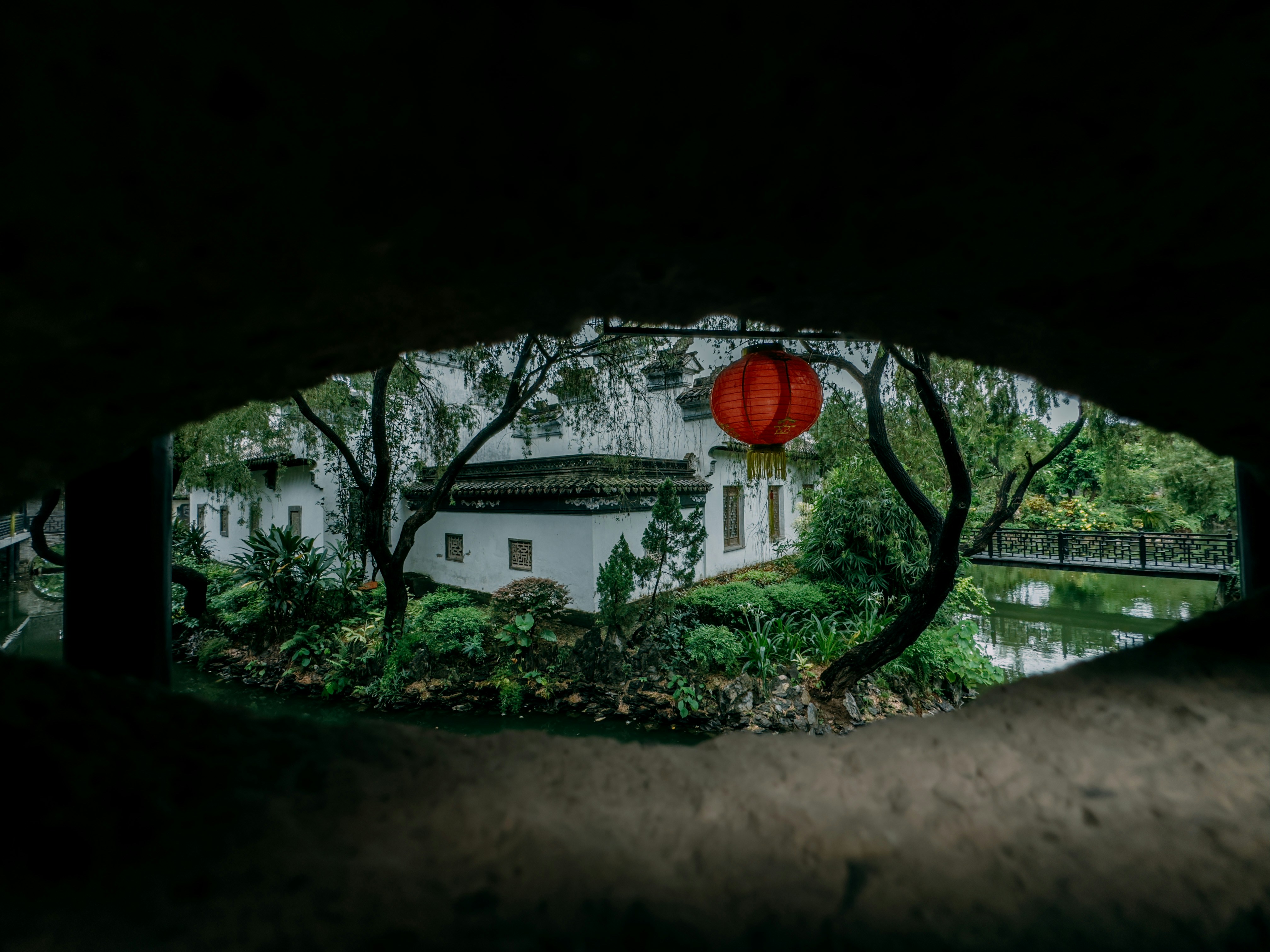 Red Lantern in a Hidden Courtyard Seen Through a Molten Arch