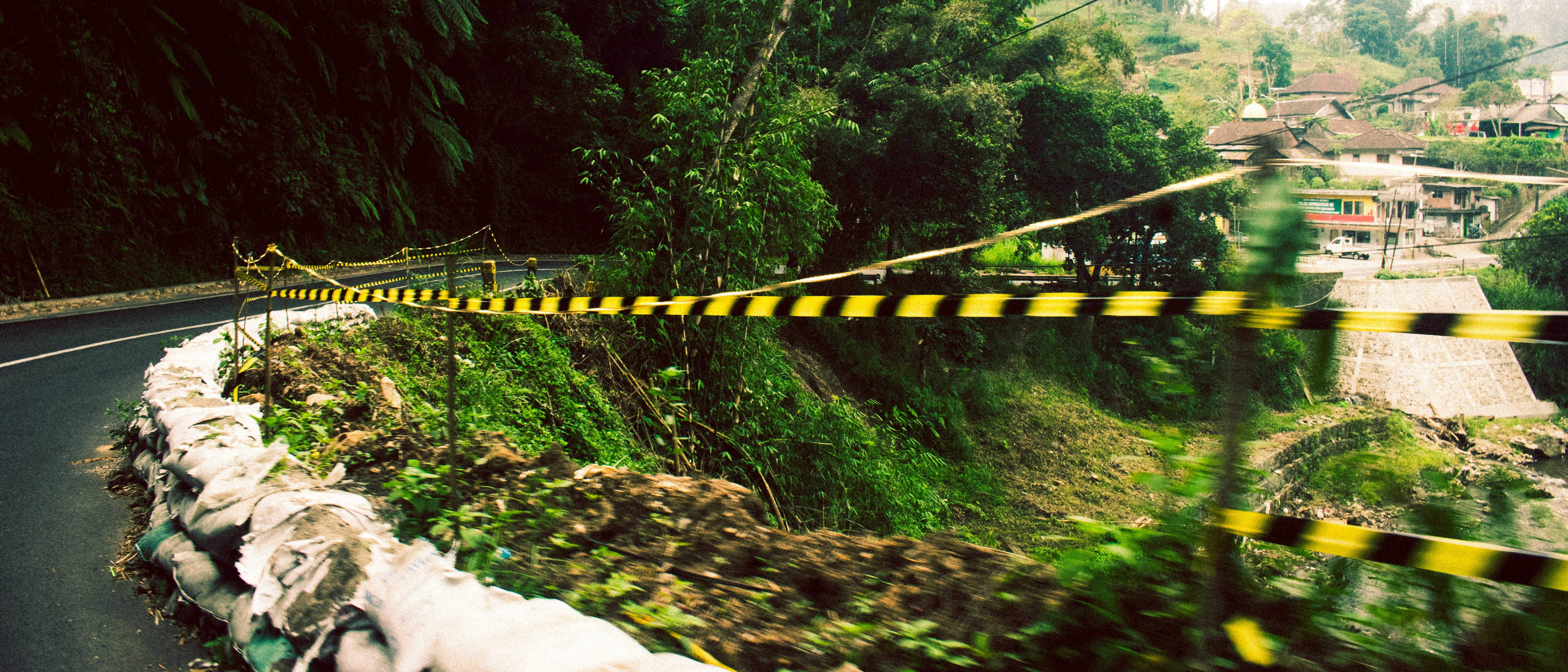 A road that has been blocked off by yellow tape photo – Free Outdoors ...