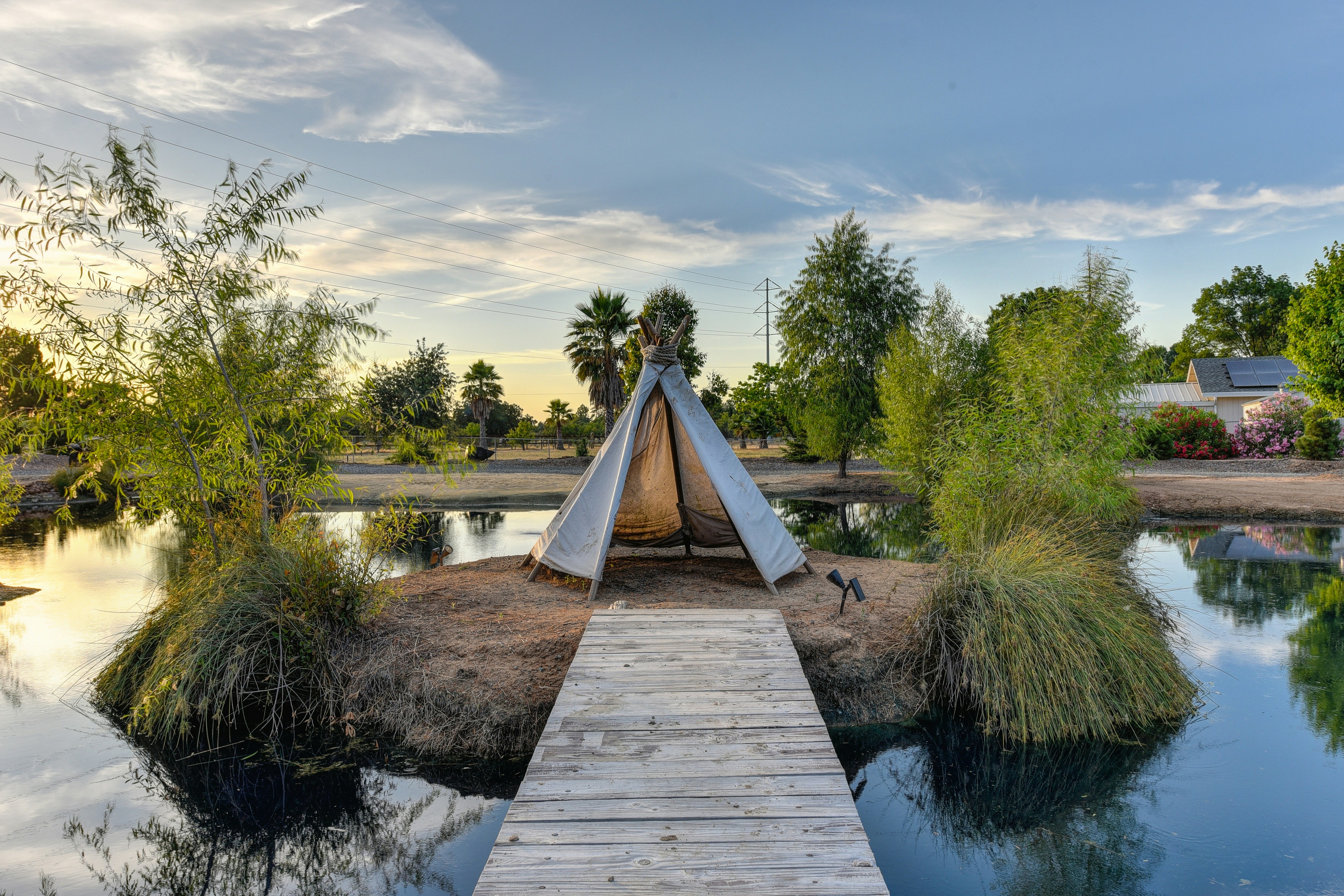 A wooden dock leading to a tent on a small island photo – Free Land ...