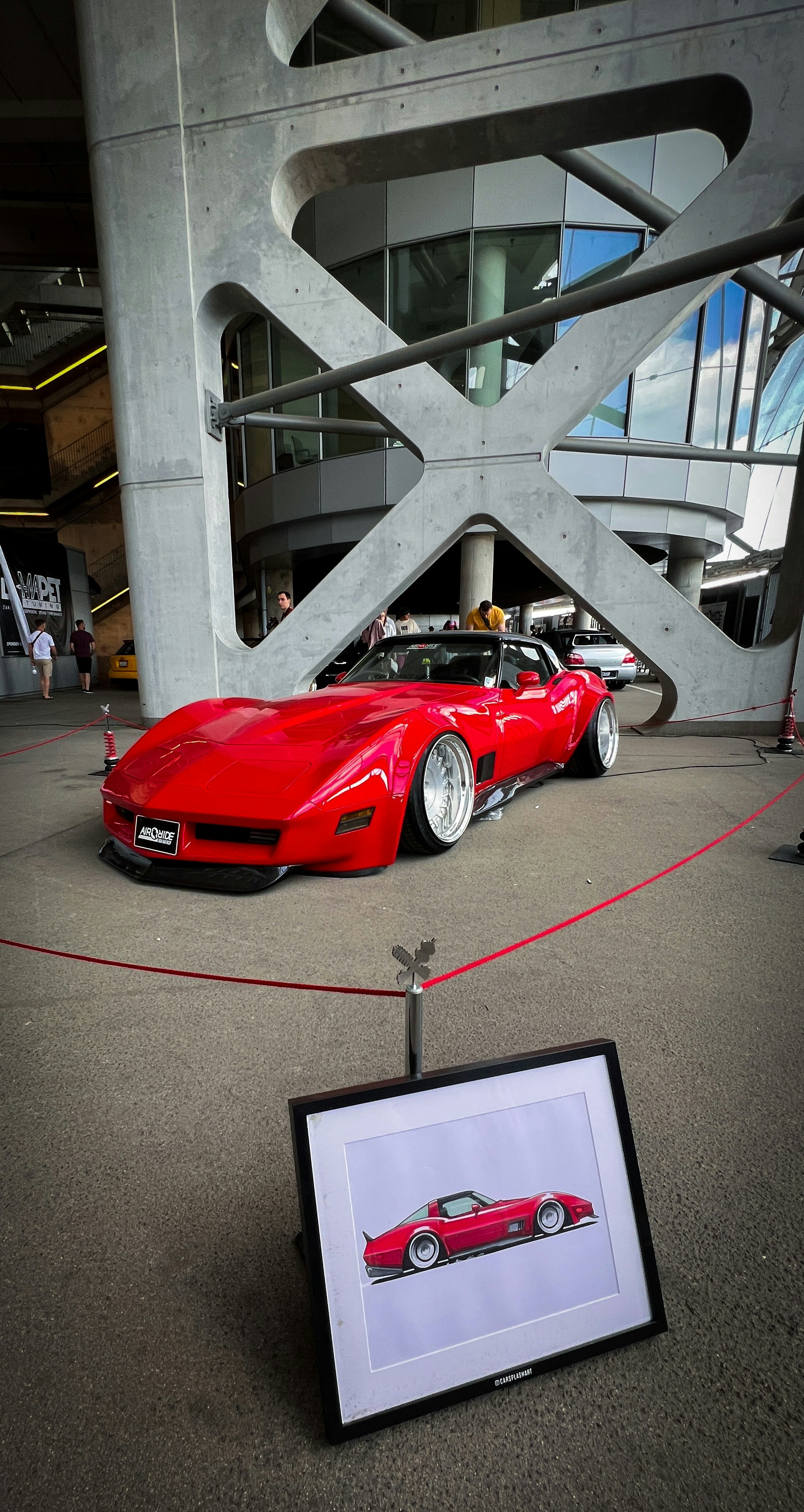 Red Mirage: A Low-Slung Corvette Under Concrete Arches