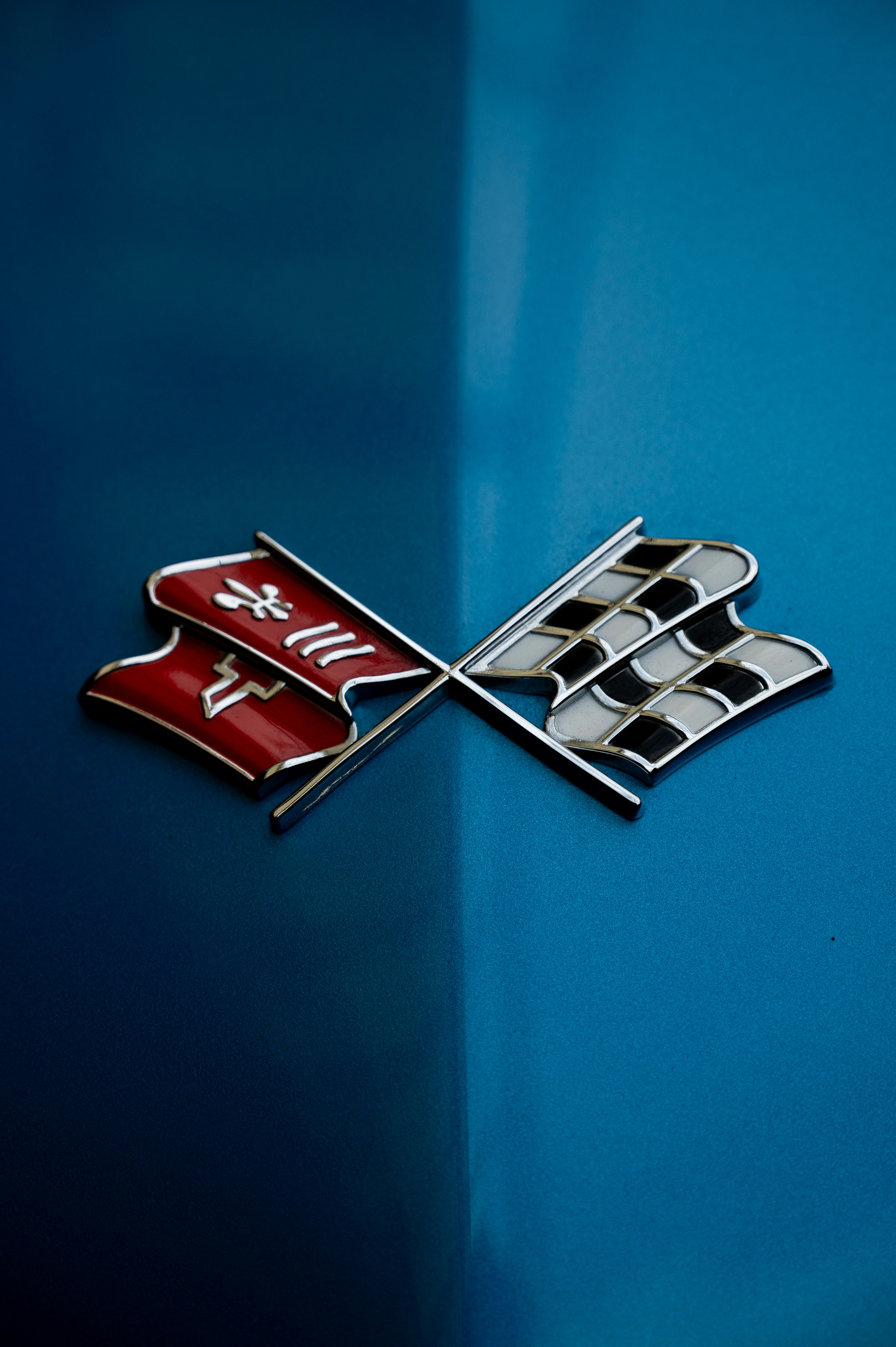 Crossed Corvette Emblems on a Deep Blue Backdrop